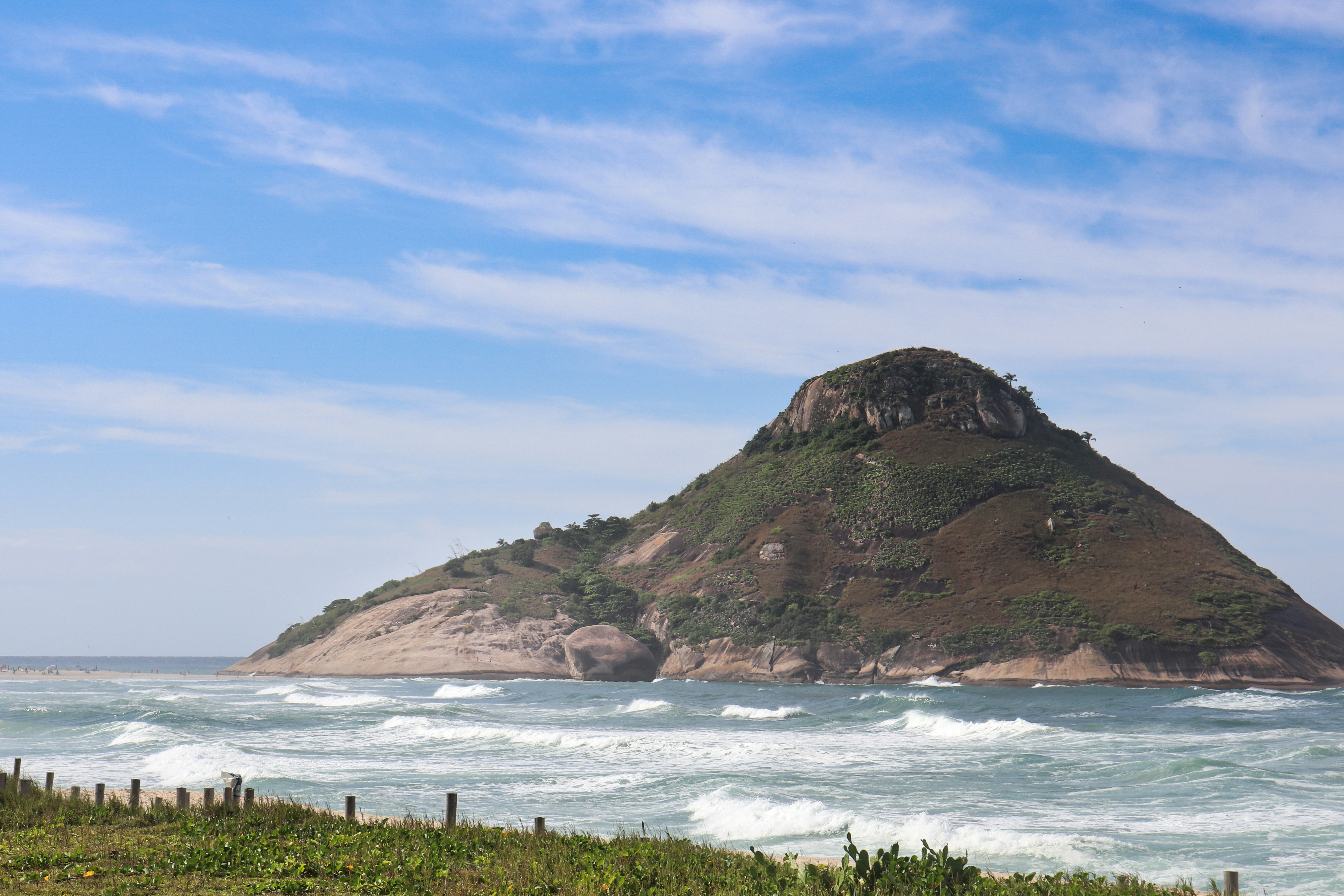 Isolated Island Amidst Rolling Waves
