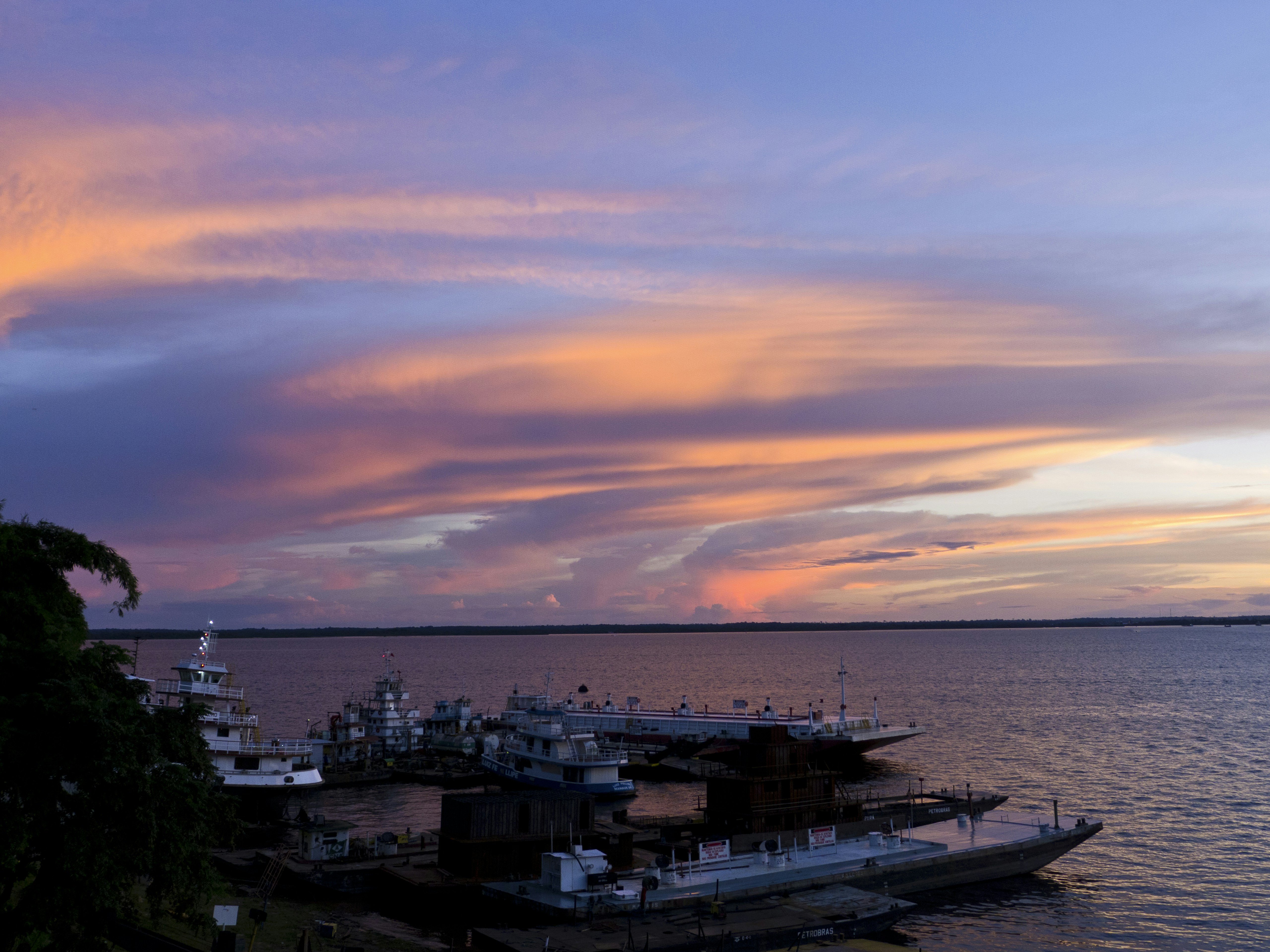 Dusk at the Harbor: Boats Rest Beneath a Peach-and-Indigo Sky