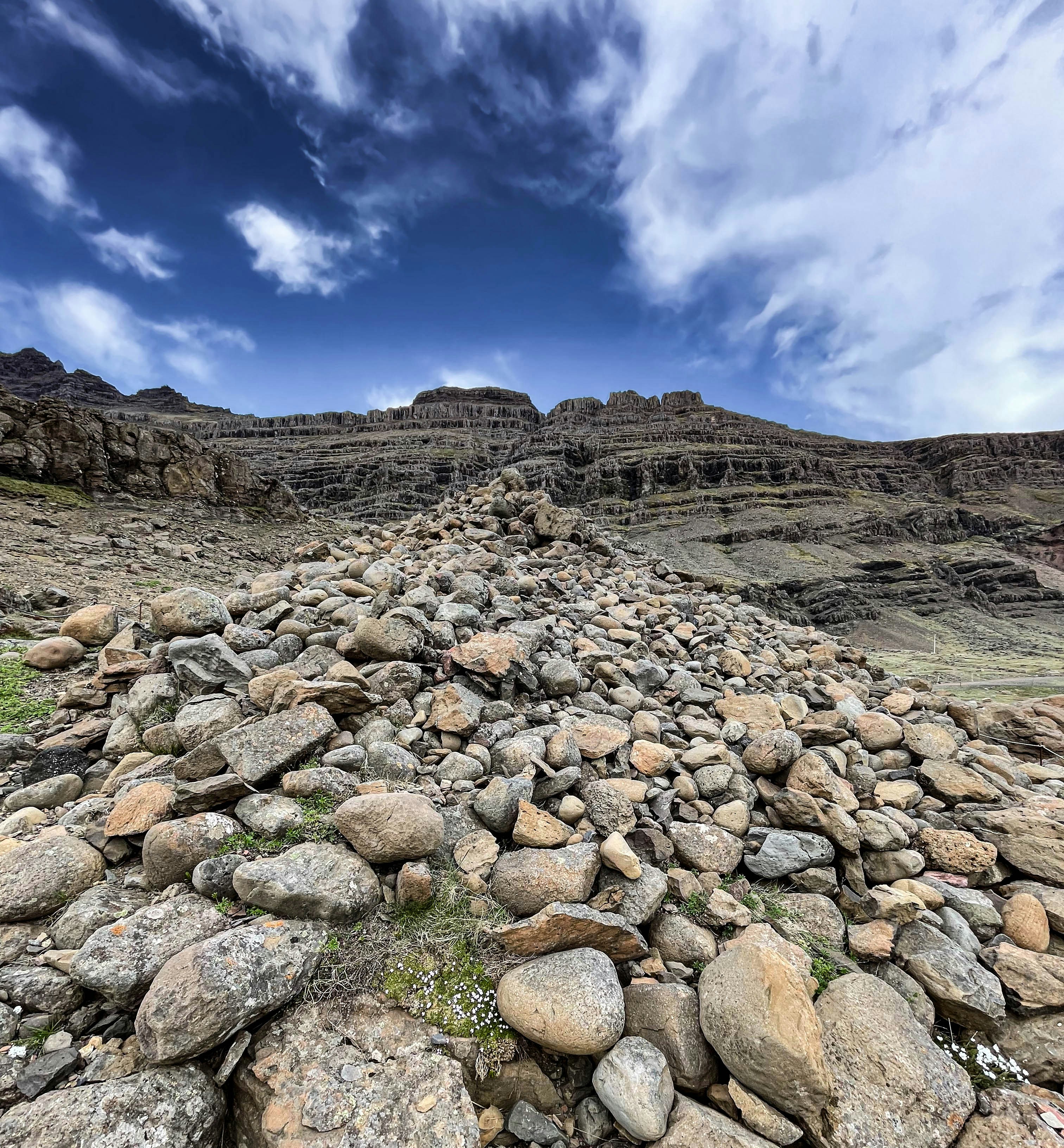 A large pile of rocks sitting on the side of a mountain photo – Free ...