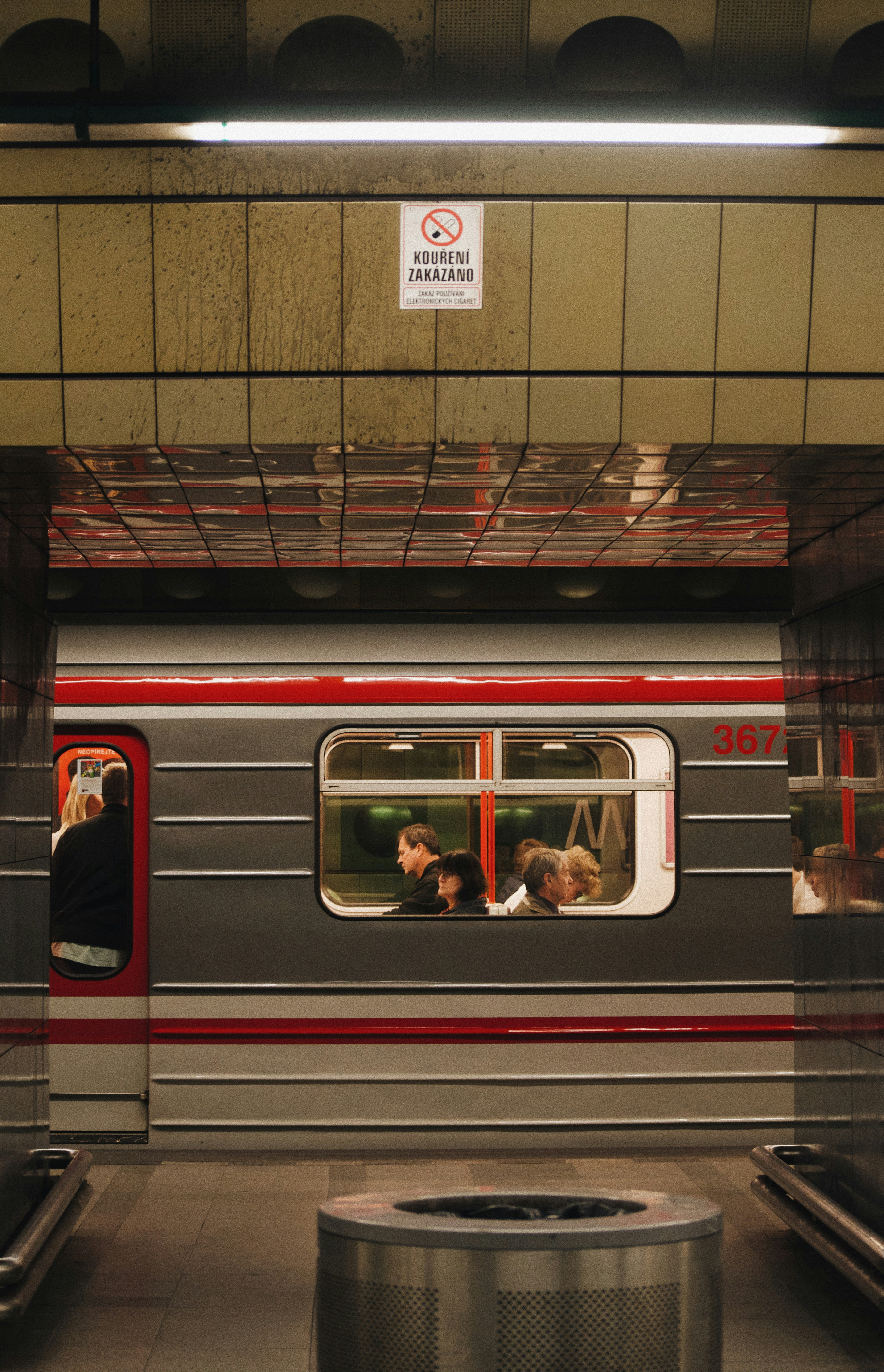 Red-Trim Subway Window: Quiet Moments Among Commuters