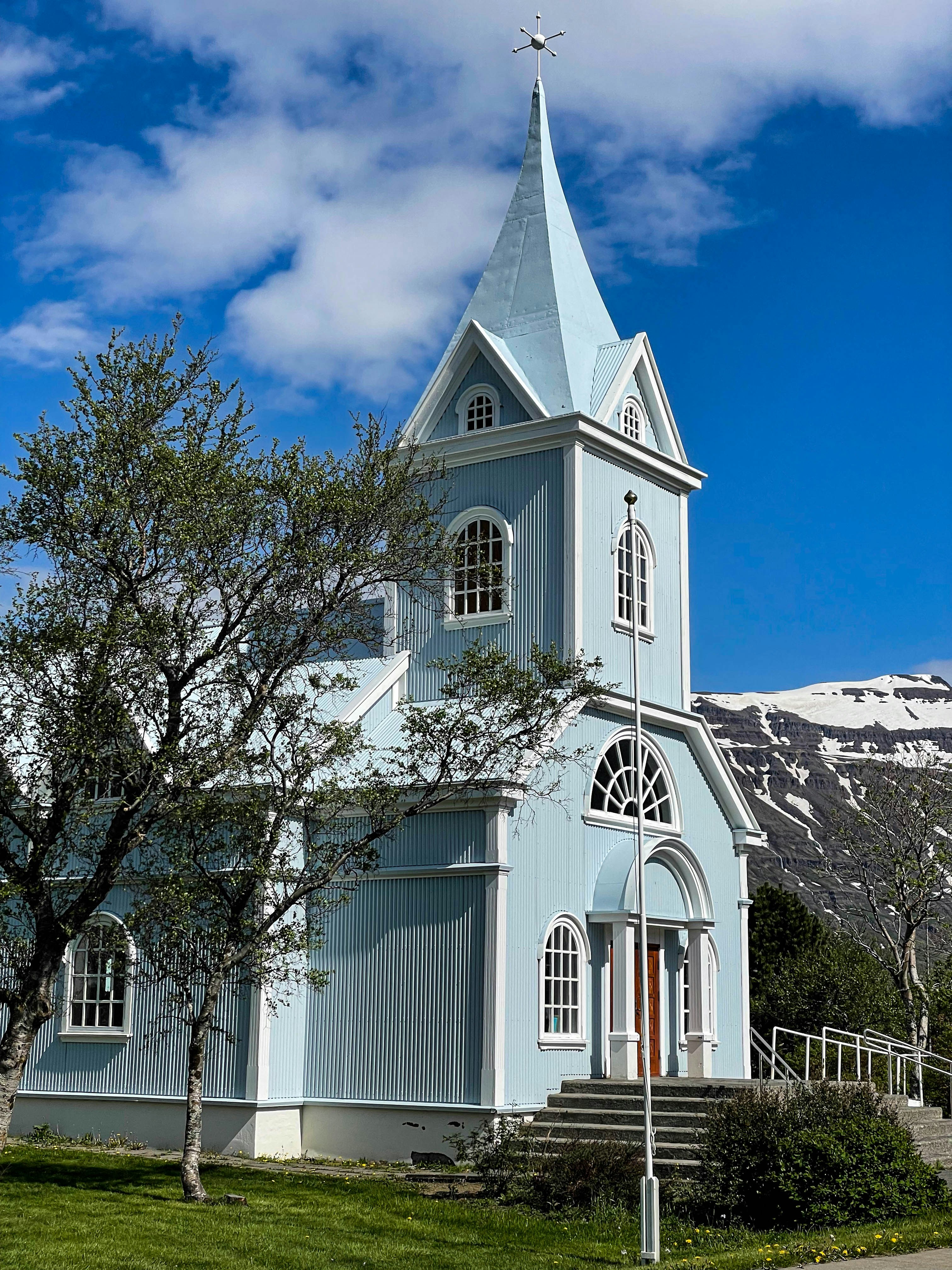 Azure Chapel by Snow-Capped Peaks Under a Clear Nordic Sky