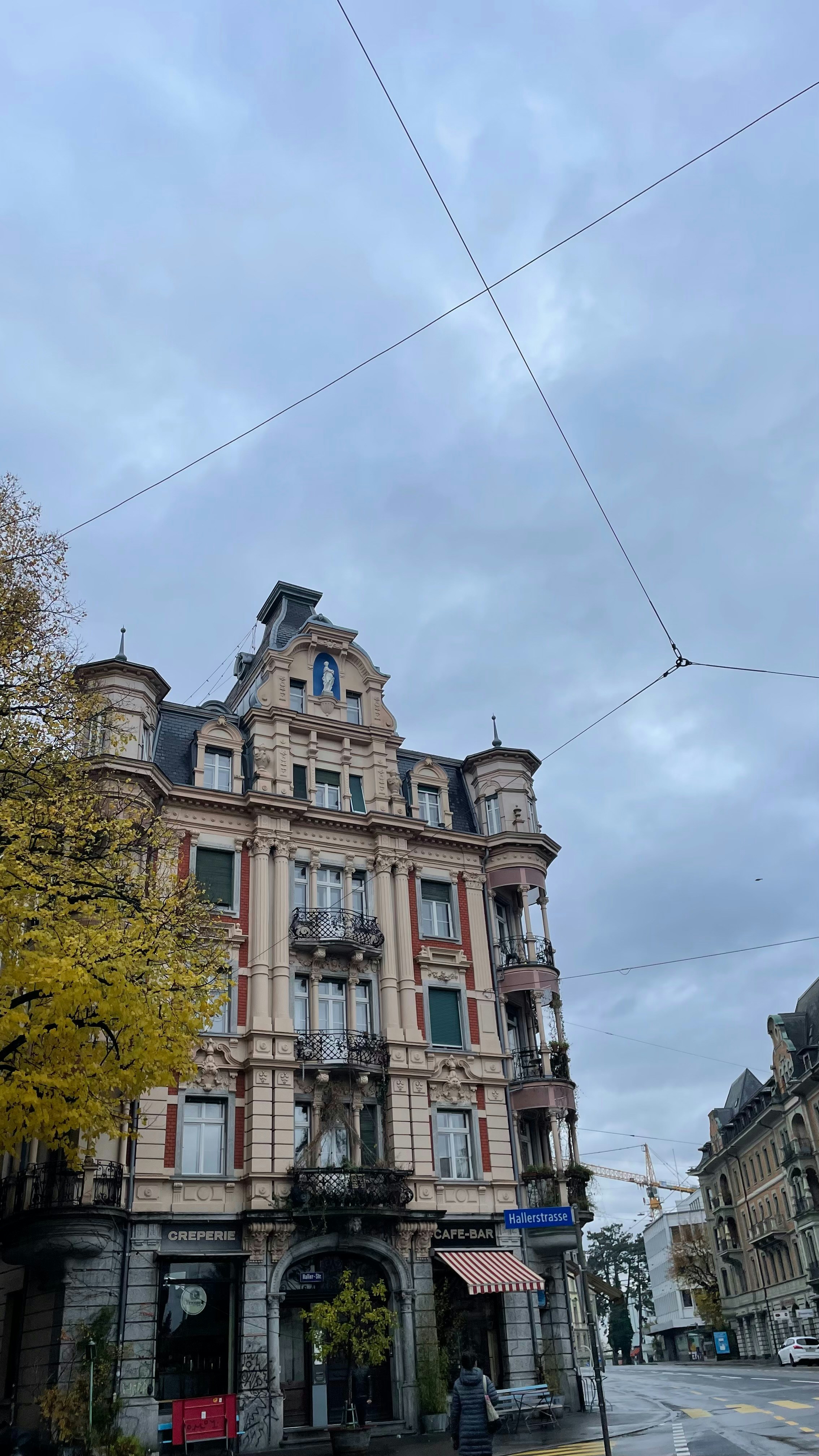 Ornate Corner Facade Under a Cloudy European Sky