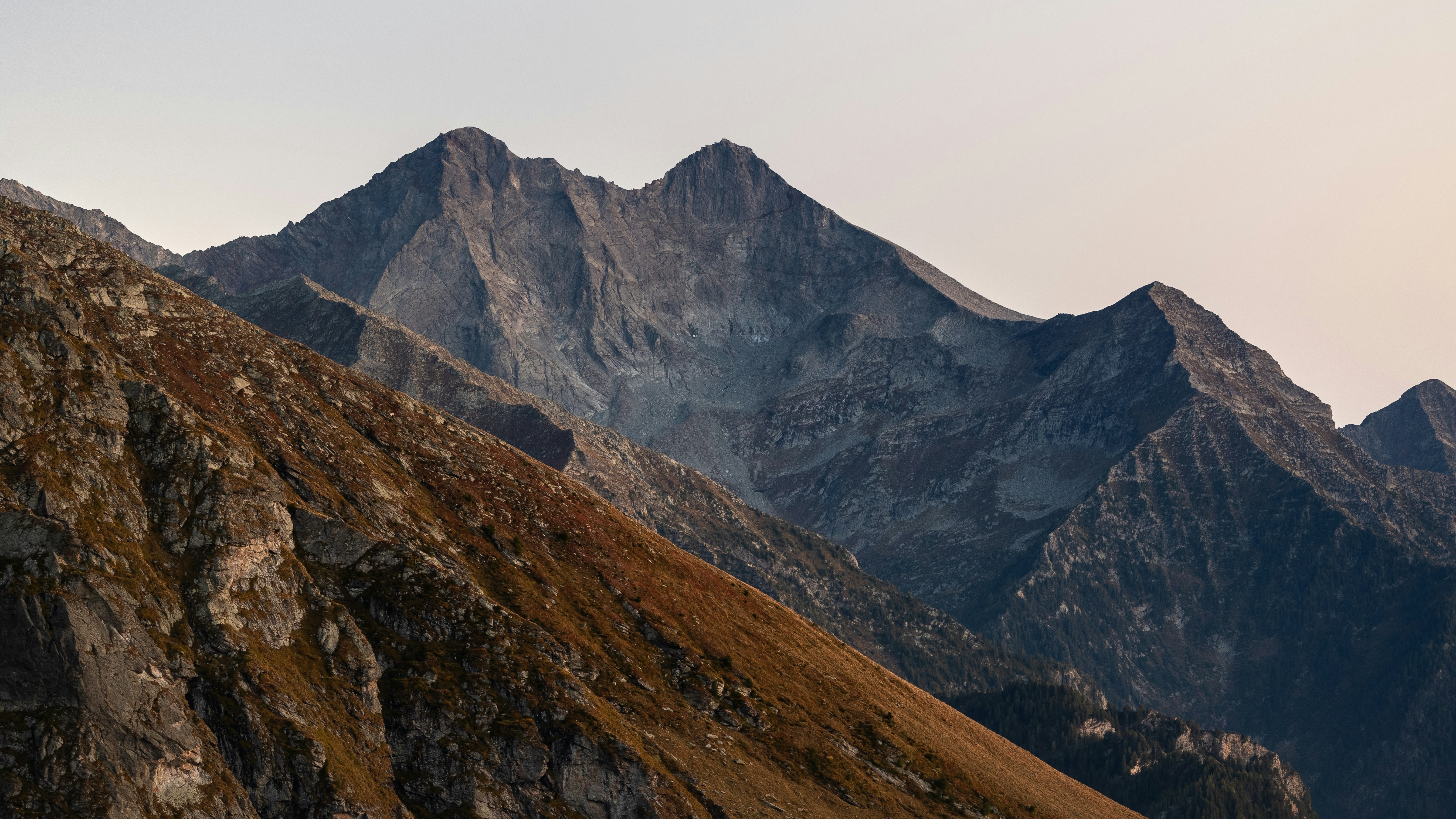 A view of a mountain range from the top of a hill photo – Free Brusson ...