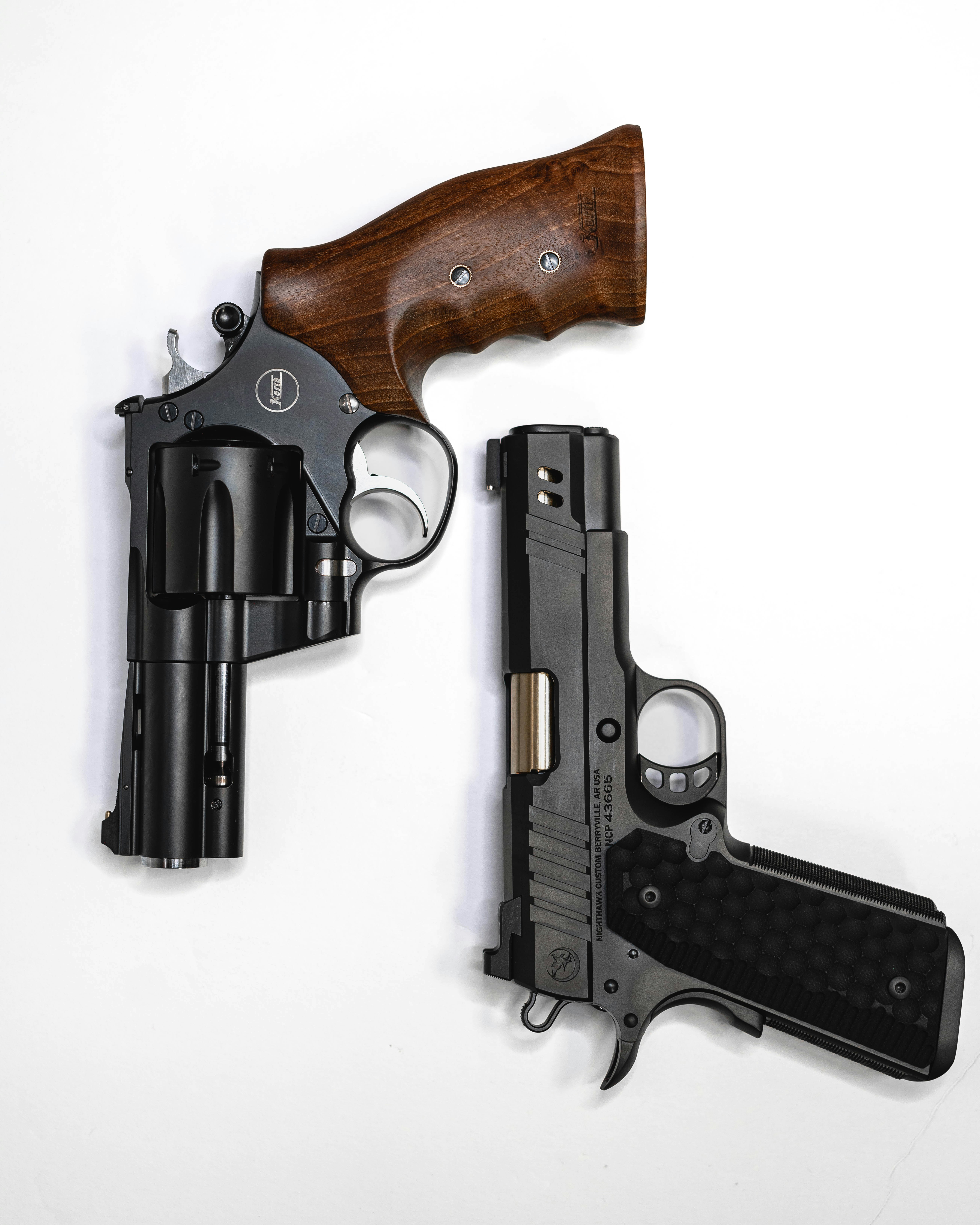 A couple of guns sitting next to each other photo – Free Handgun Image ...