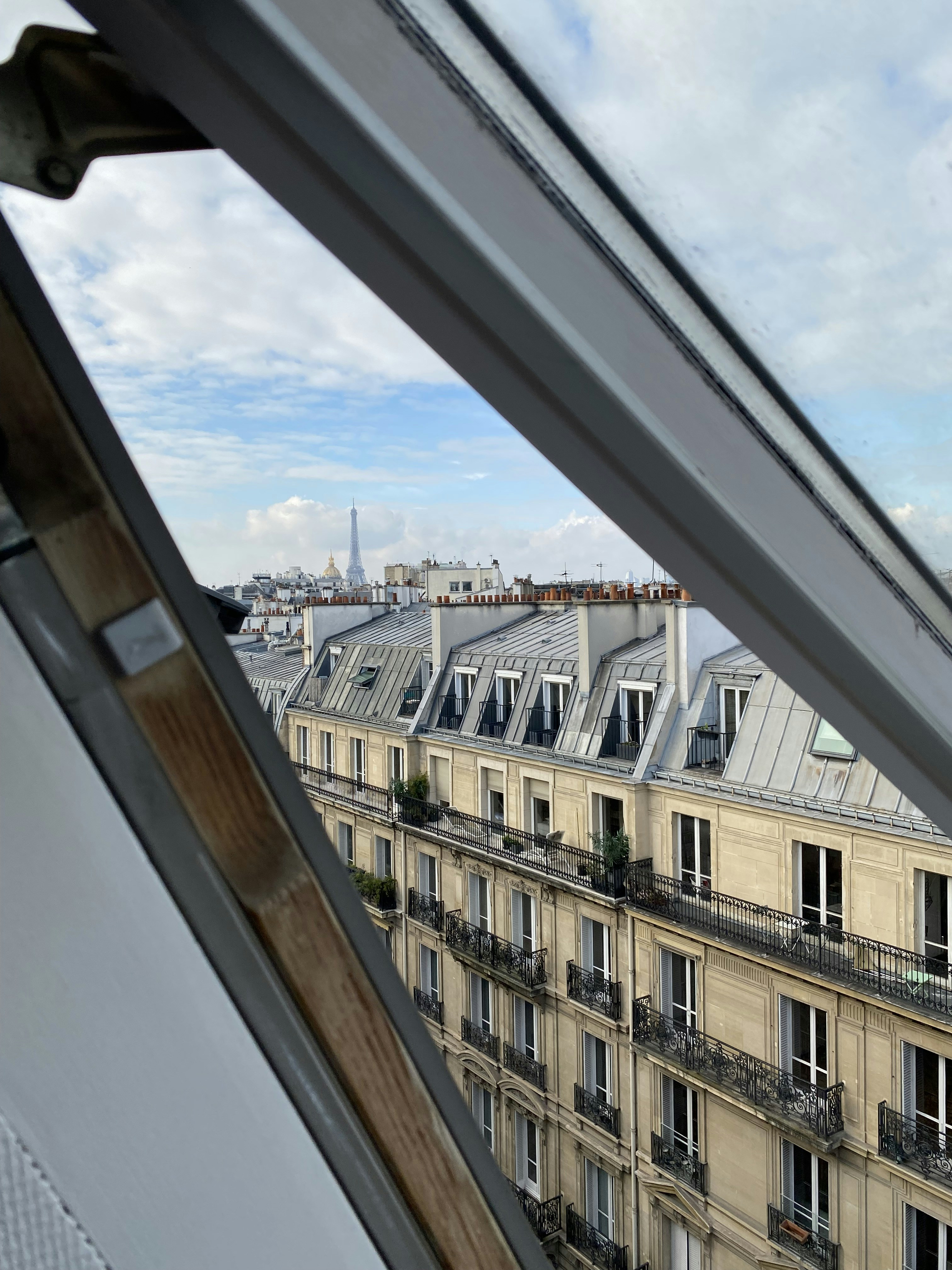 Tilted Window Panorama: Haussmann Rooftops and the Distant Eiffel Tower
