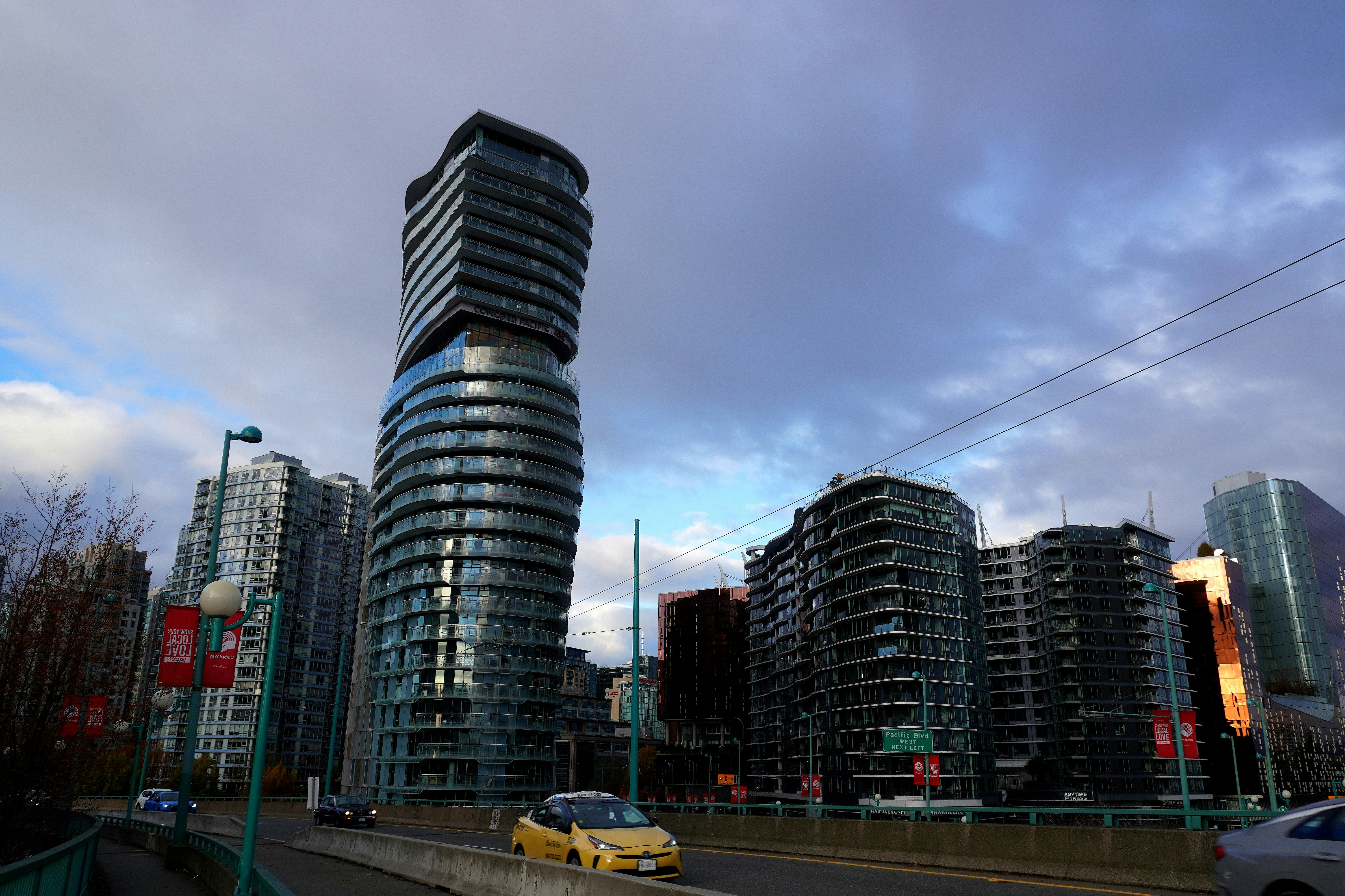 Spiral Glass Tower Rising Over a Busy Downtown Boulevard