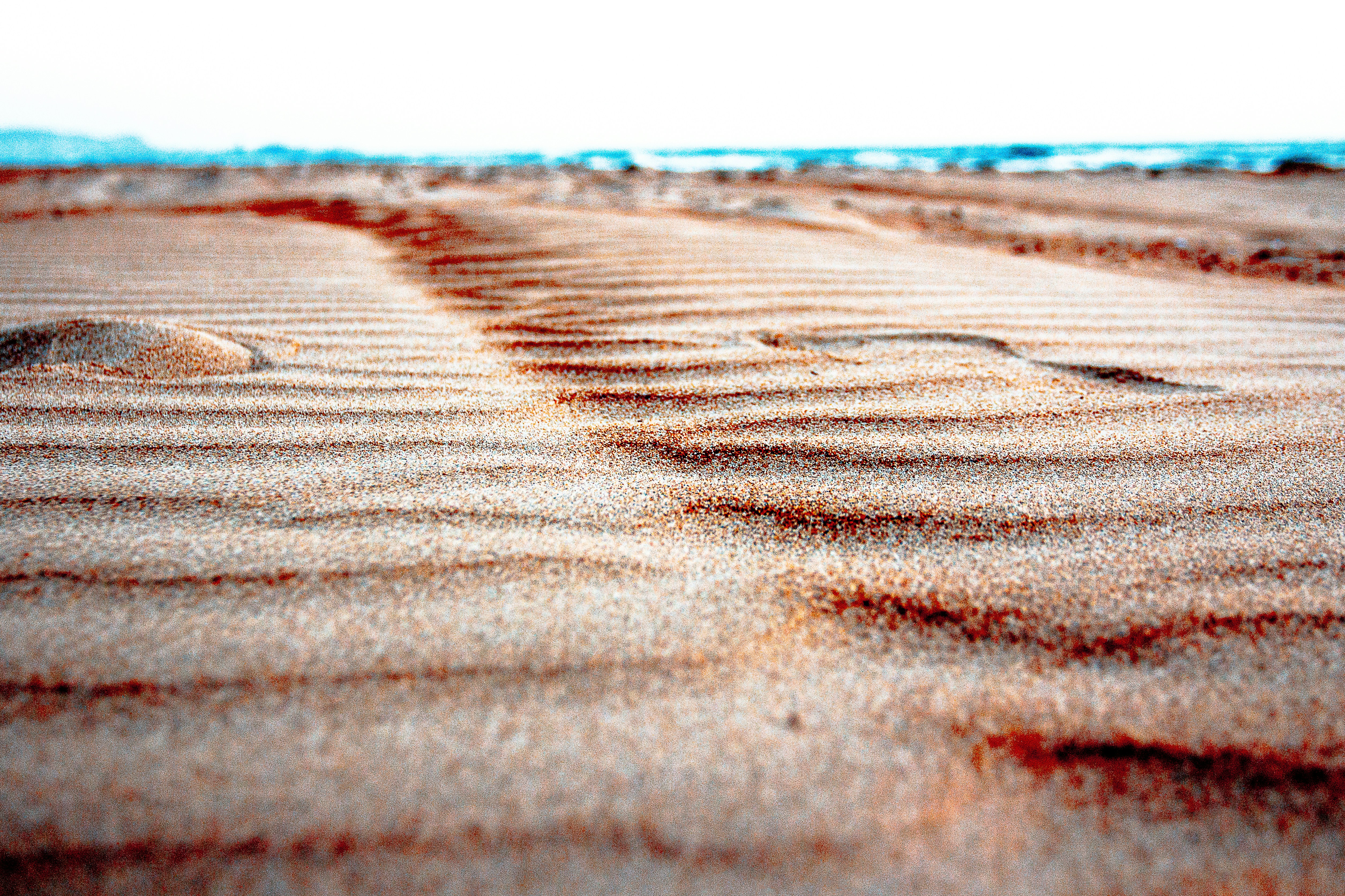 Ripple Trails to the Sea: Sunlit Sand Patterns on a Quiet Beach