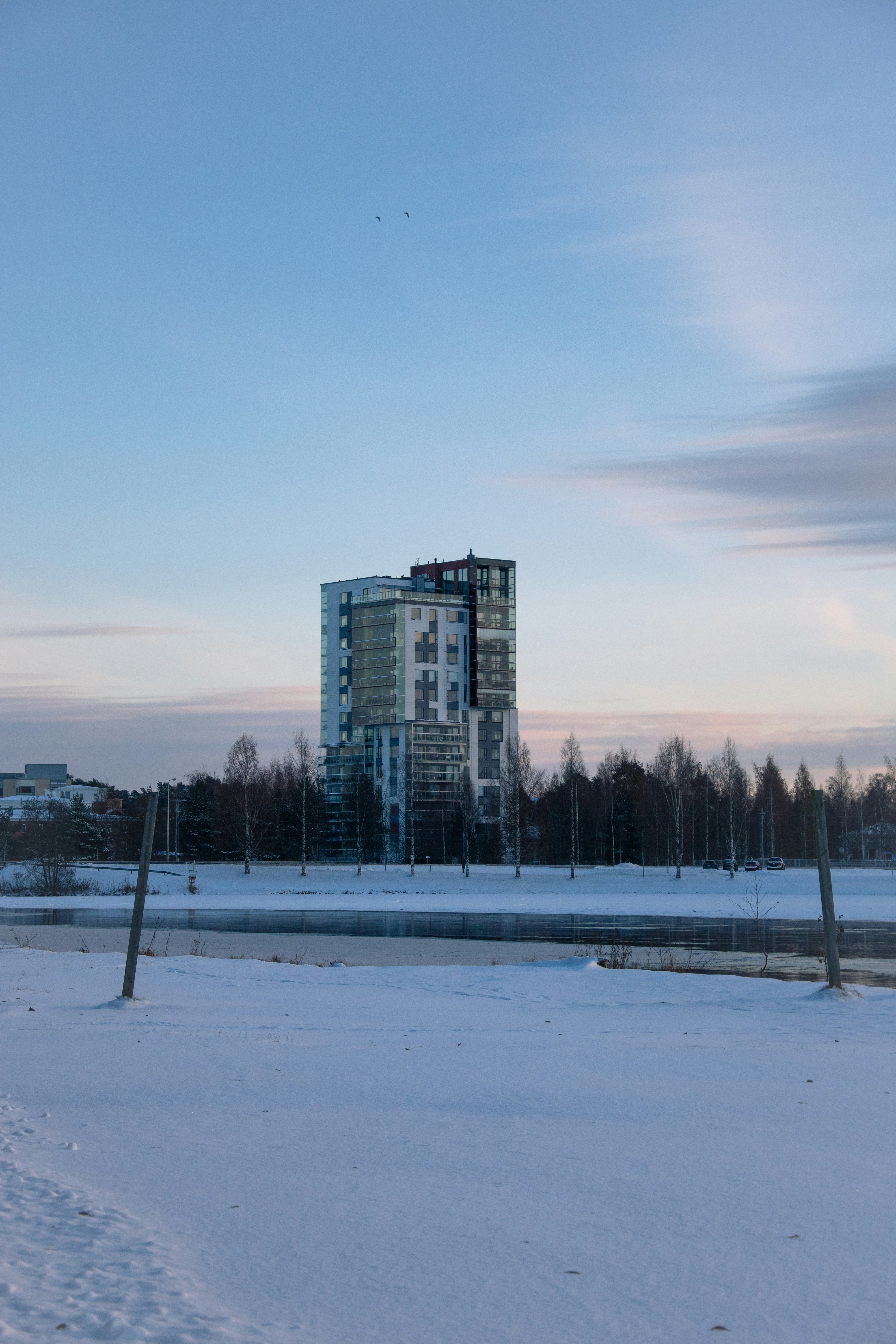 Snowbound High-Rise Emerges Amid a Cold Blue Dusk
