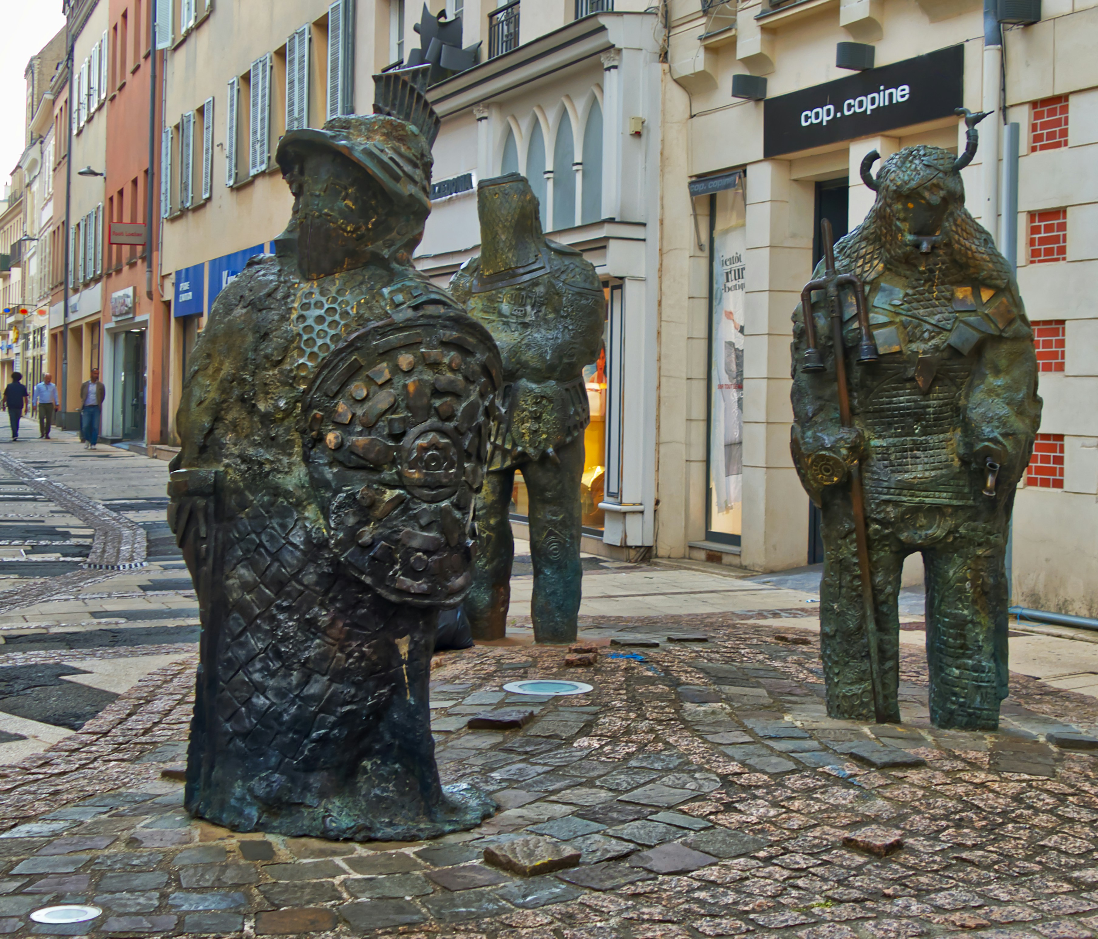 Bronze Sentinels on a Cobblestone Street