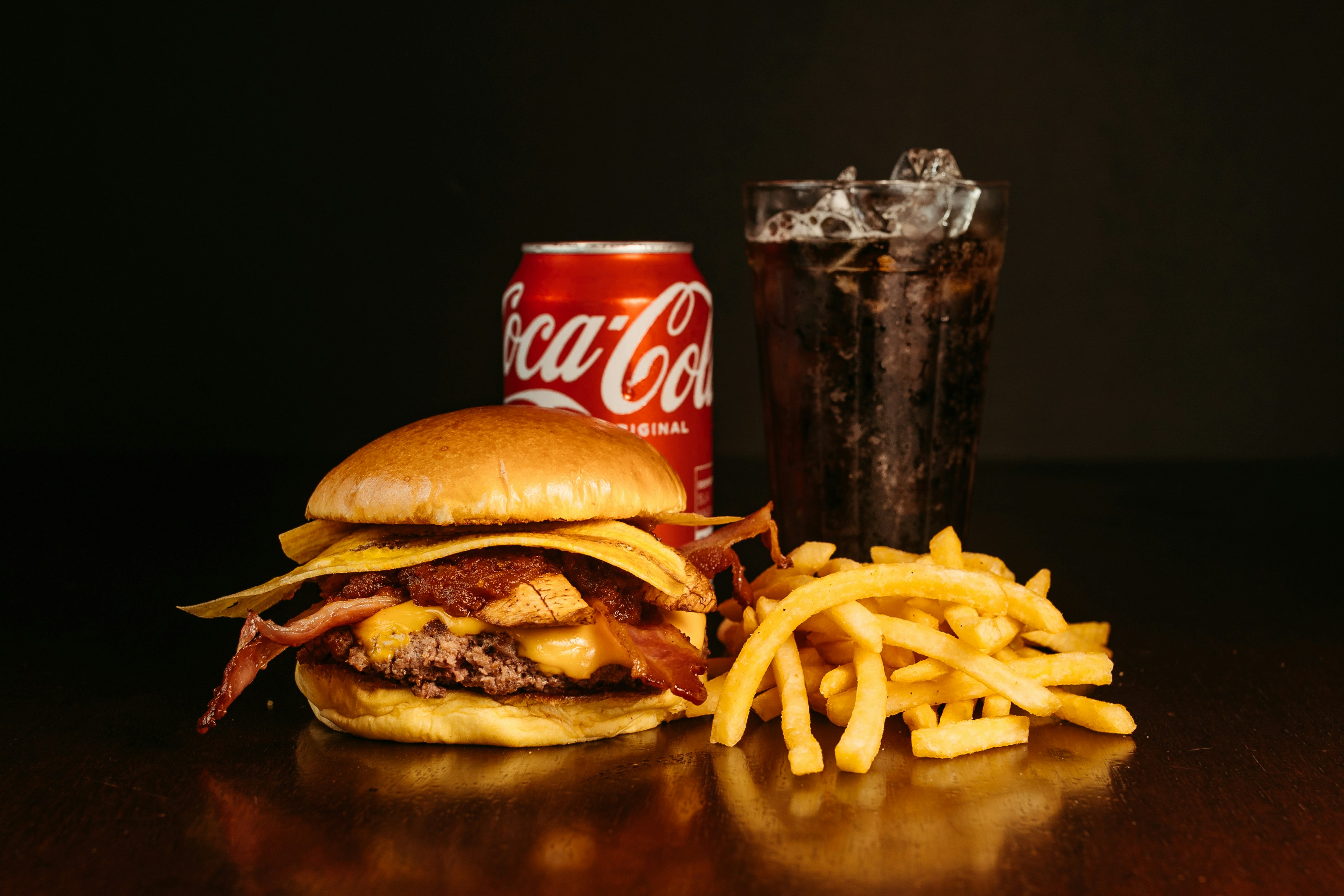 A hamburger and fries with a coke on a table photo – Free Food Image on ...