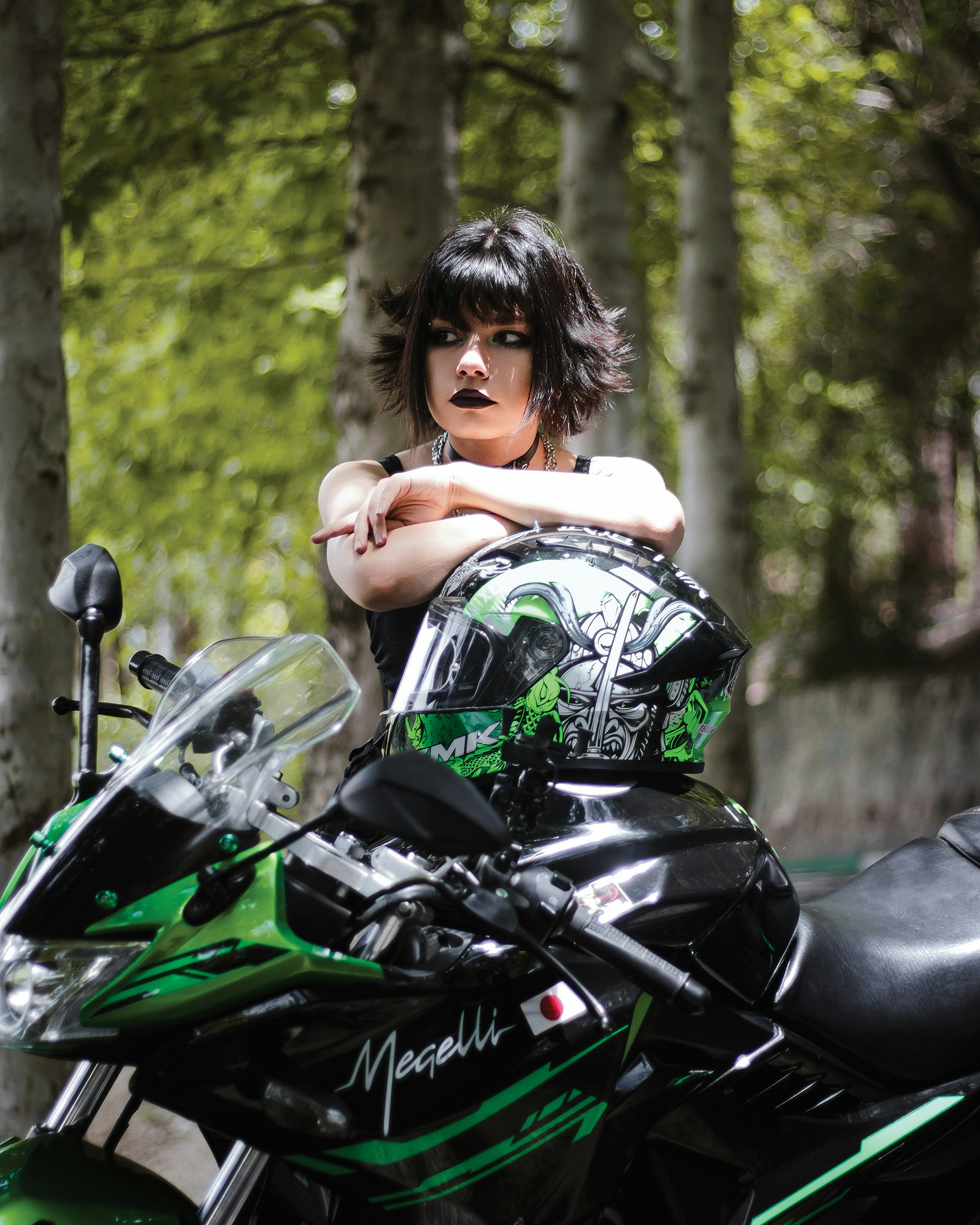  rider silhouette: bold black hair and neon green motorcycle sculpture