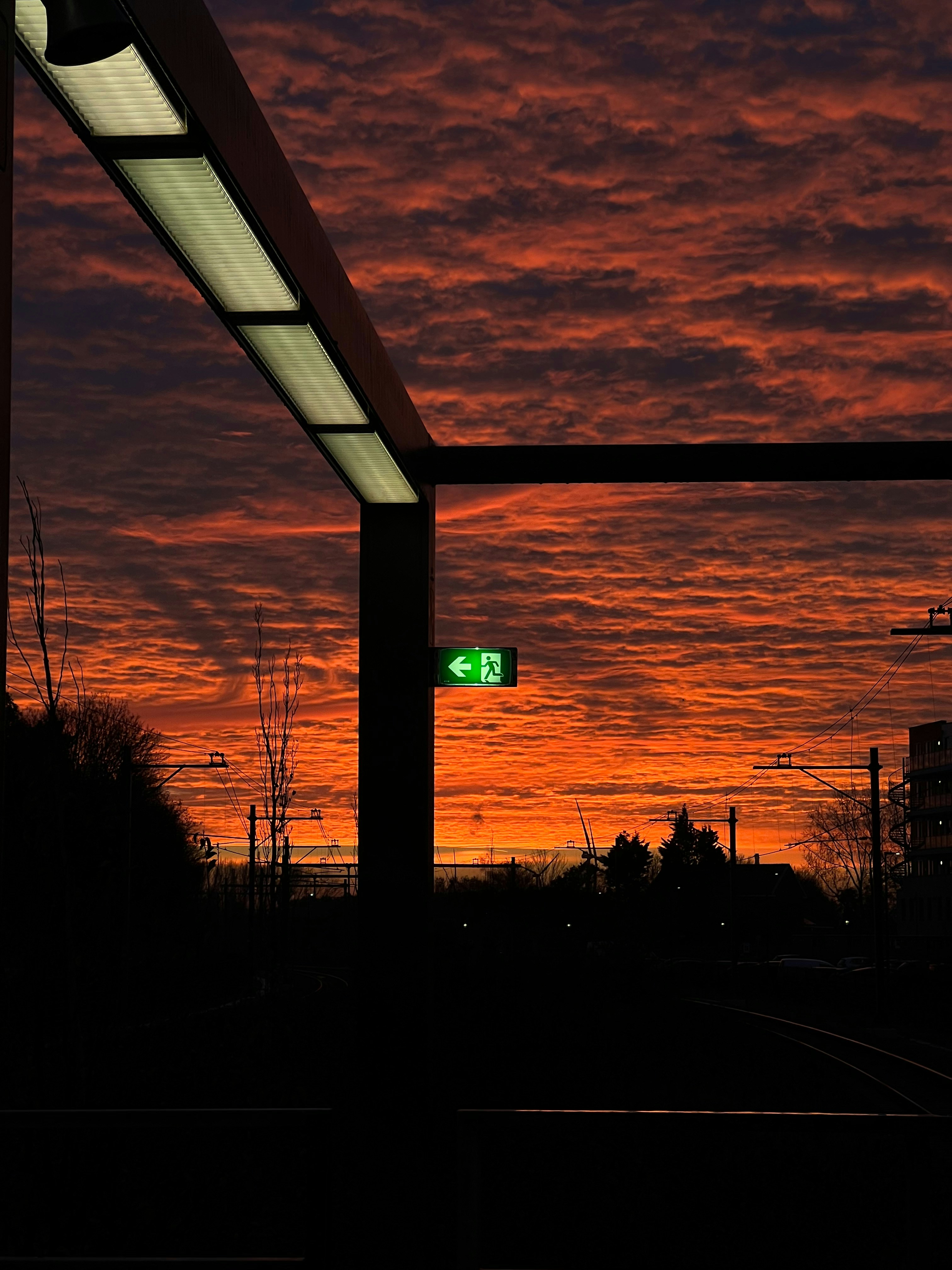 a traffic light sitting under a cloudy sky