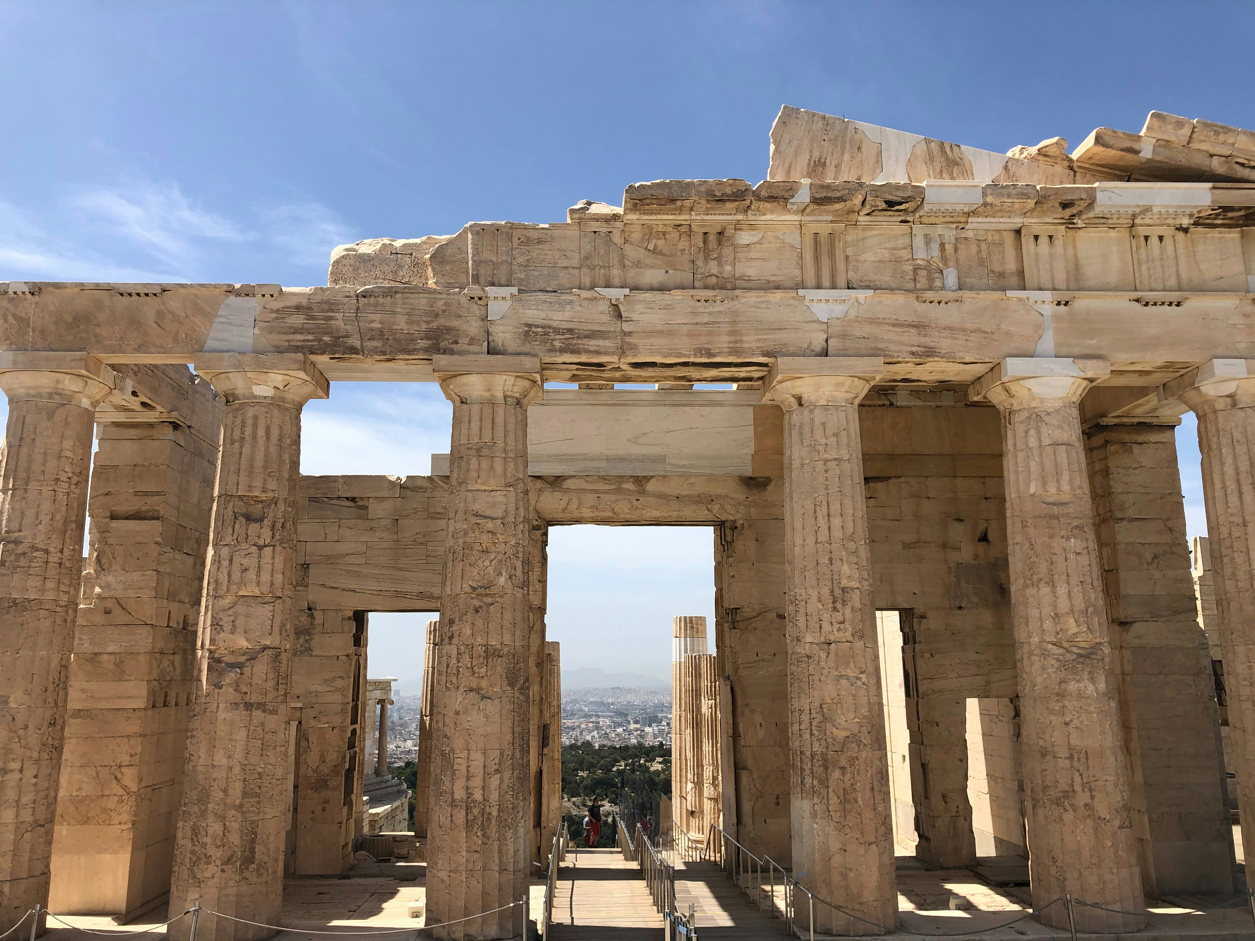 Sunlit ancient columns of the Parthenon with a clear sky backdrop.