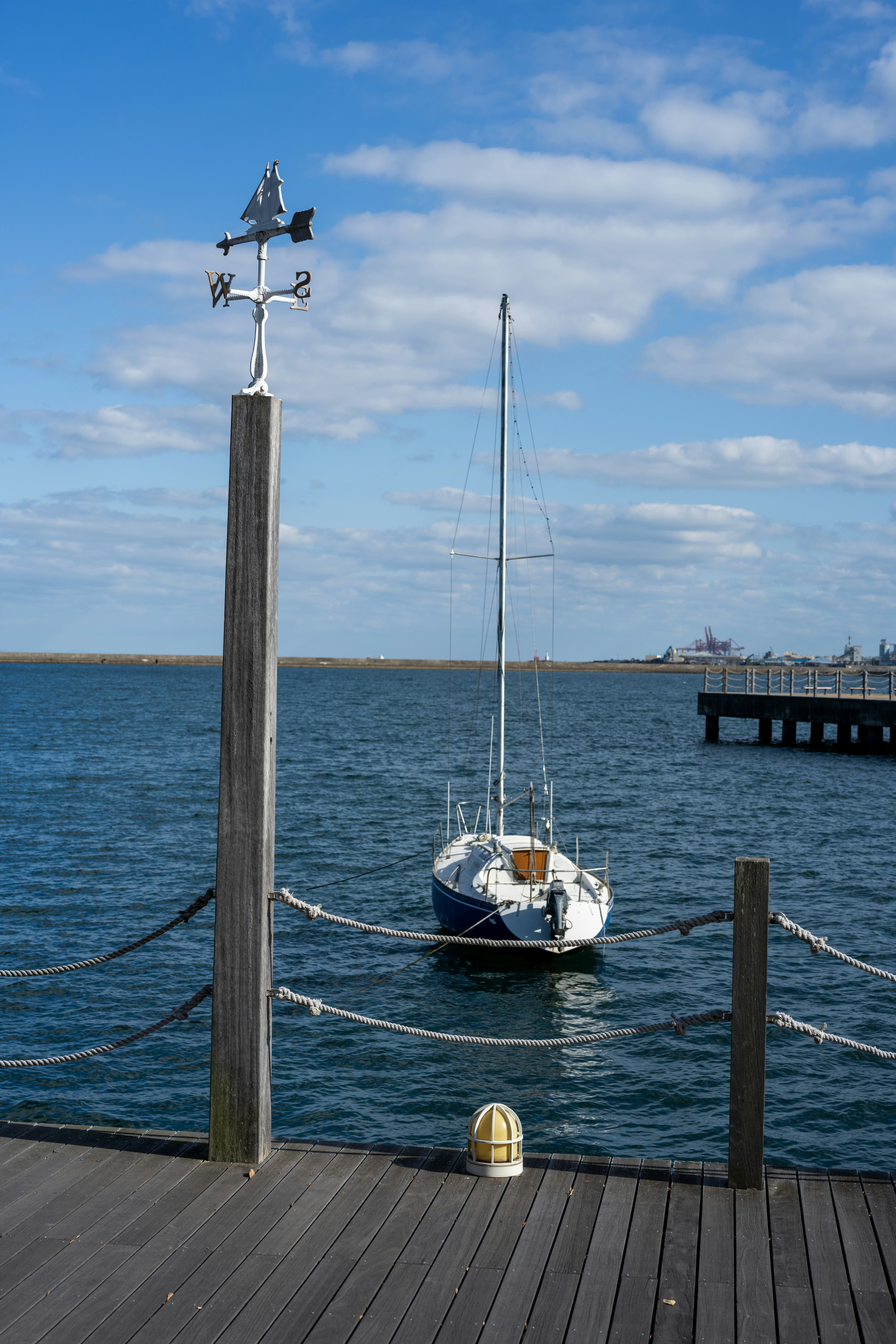 A sailboat tied up to a dock in the water photo – Free Grey Image on ...