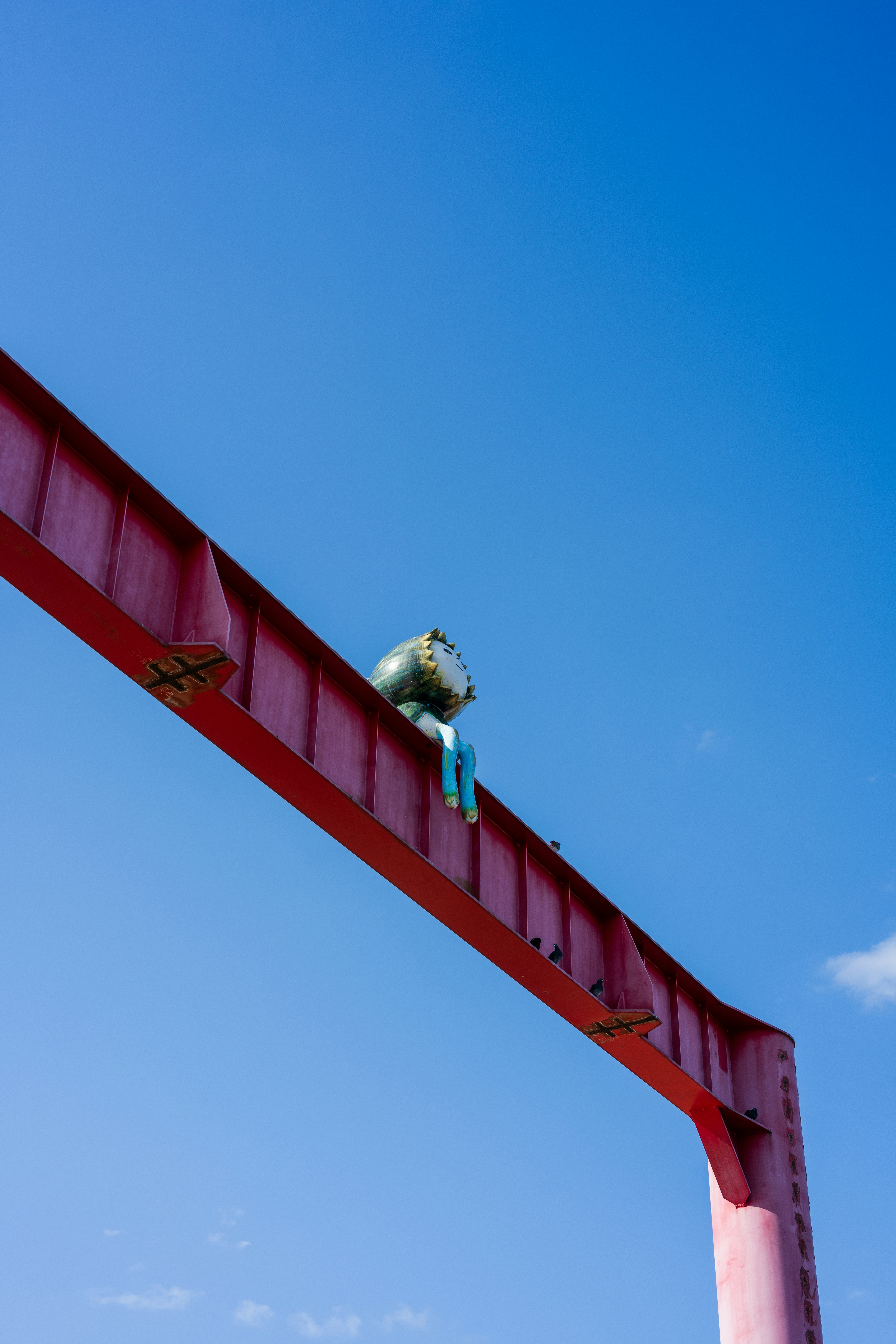 Edgewalker on a Crimson Girder in a Sky-Blue Expanse