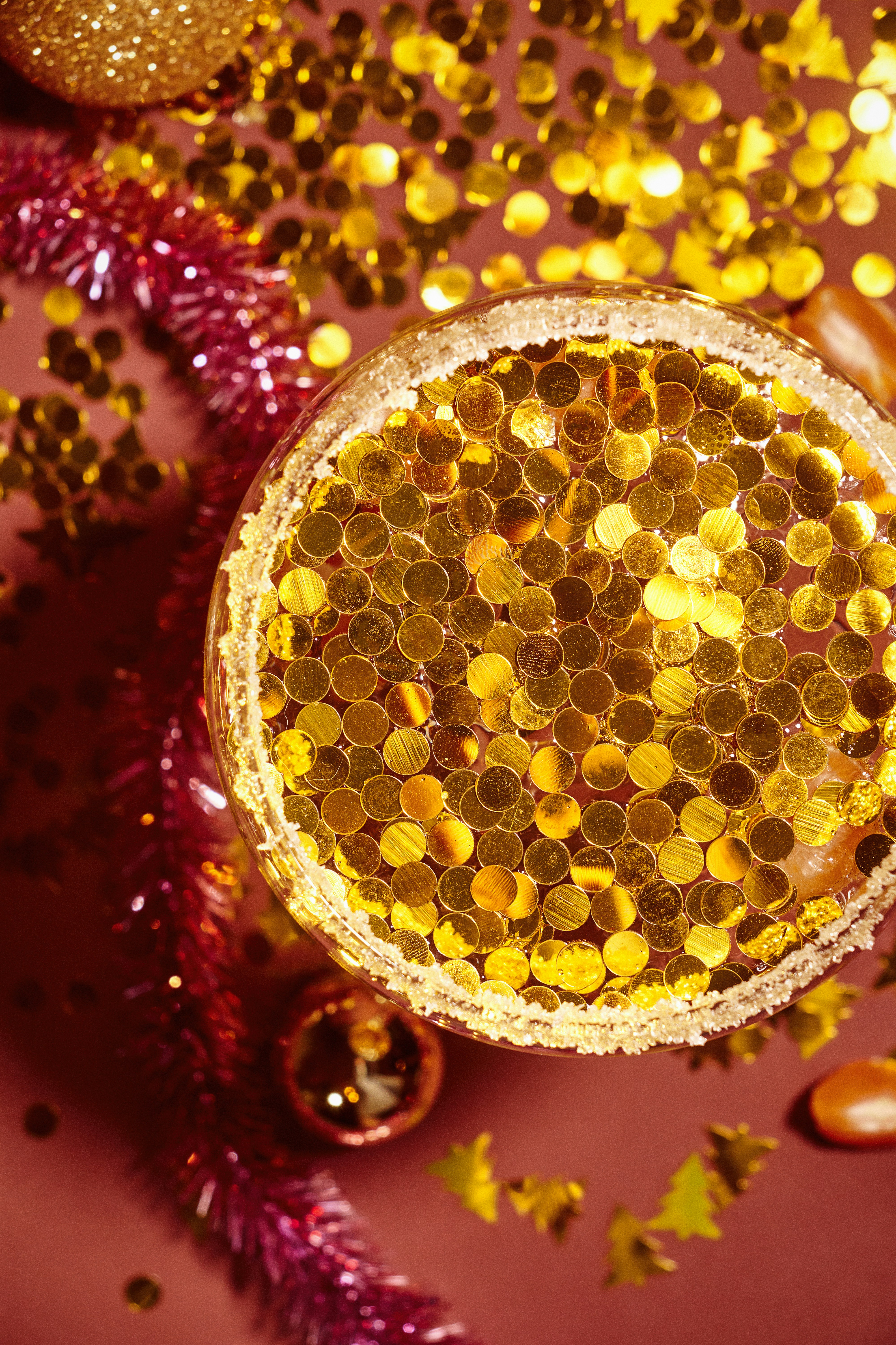 Golden Orbs: A Macro Celebration of Festive Confetti in Gelled Light
