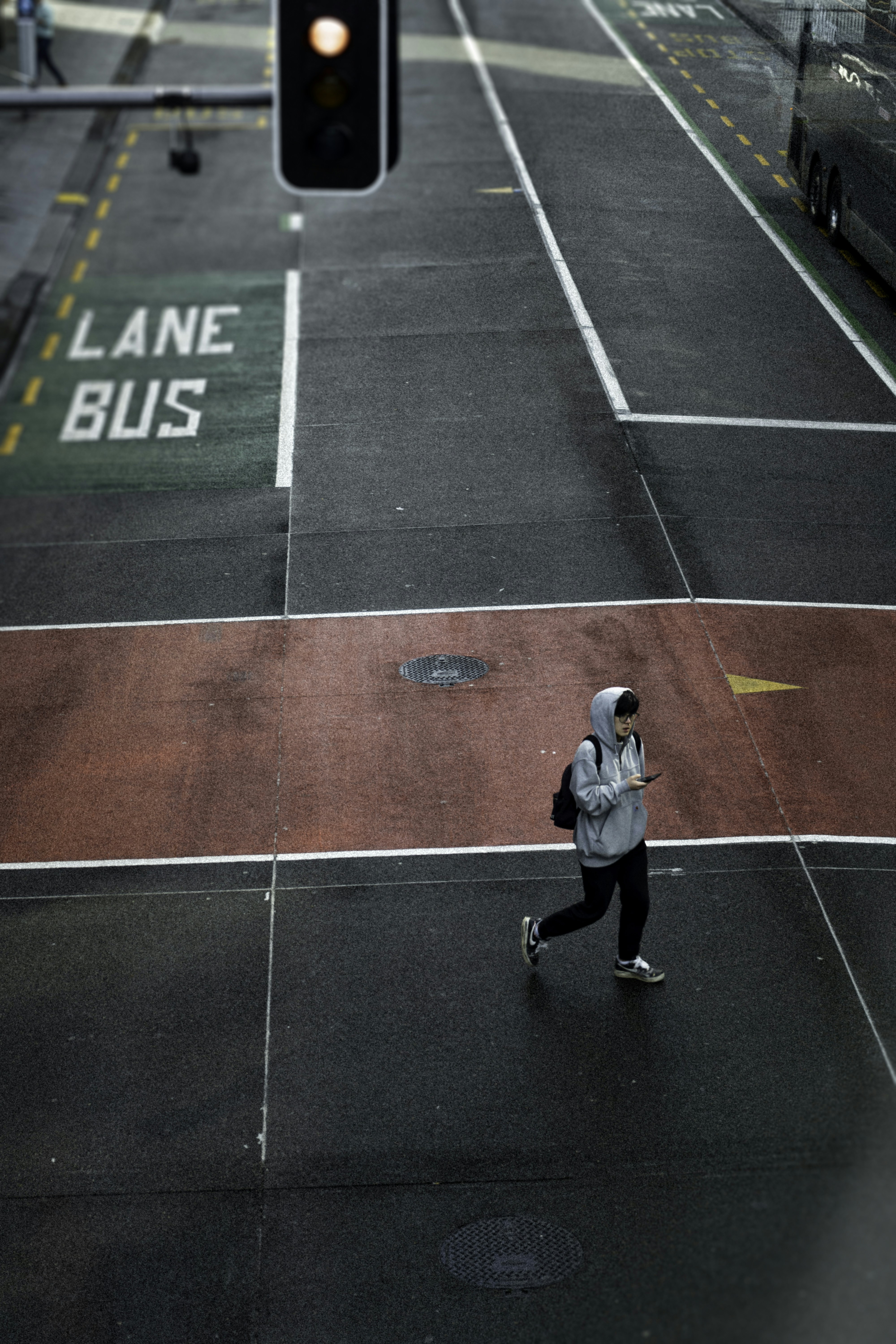 A person running across a street next to a traffic light photo – Free ...