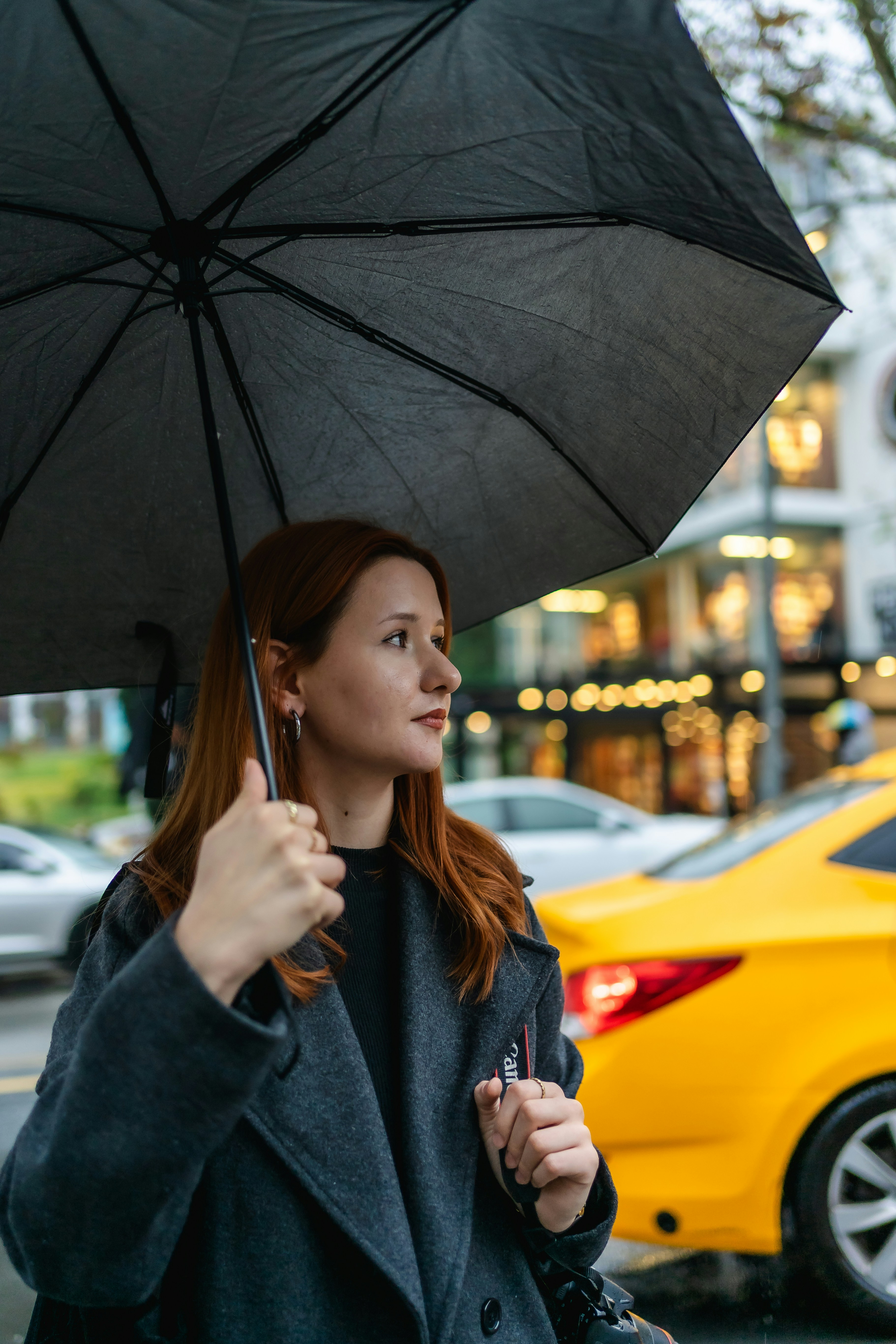 Under the City Umbrella: Portrait Framed by Rain and Neon