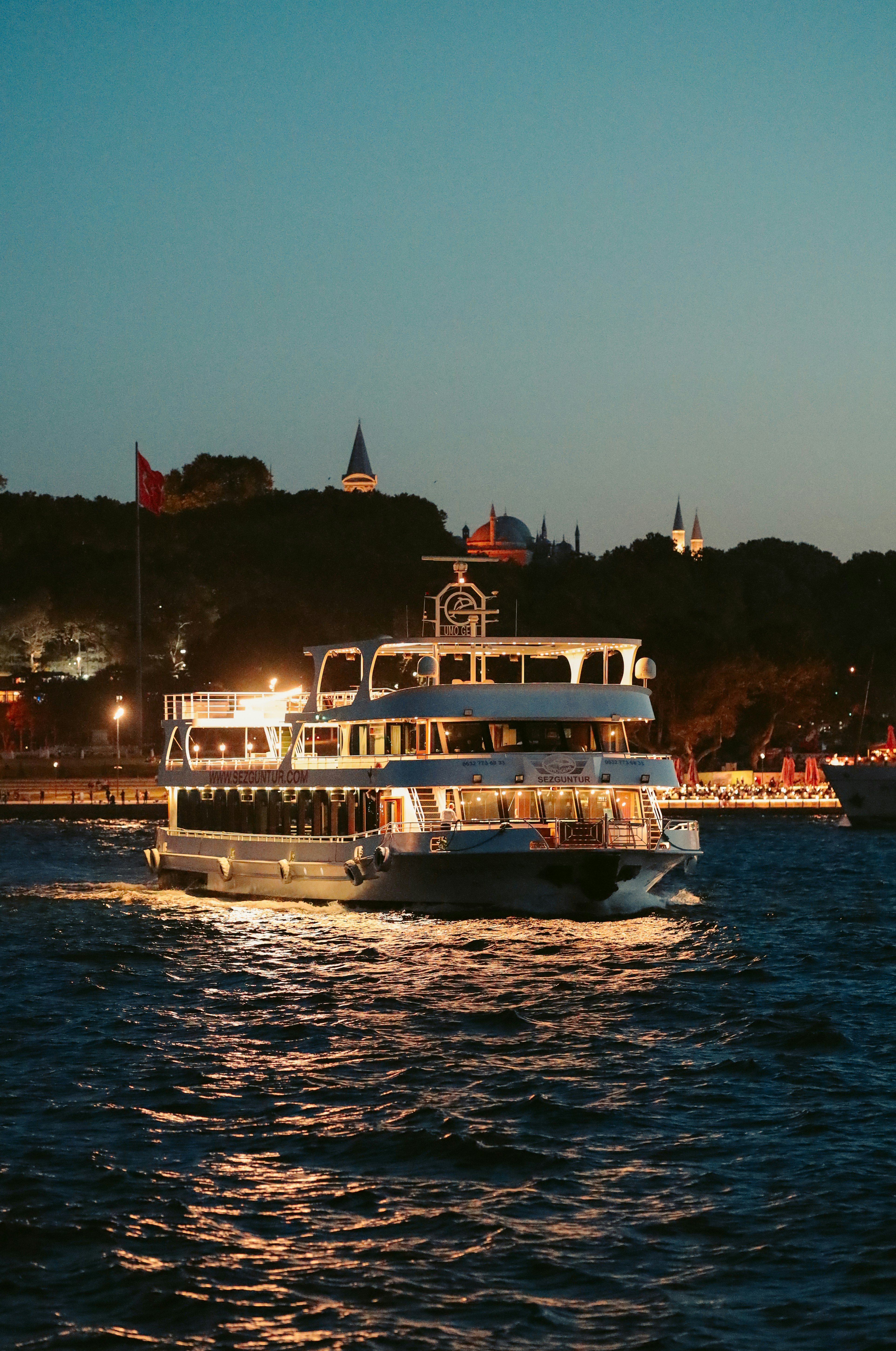 Neon-Glow Ferry Skims the River at Dusk