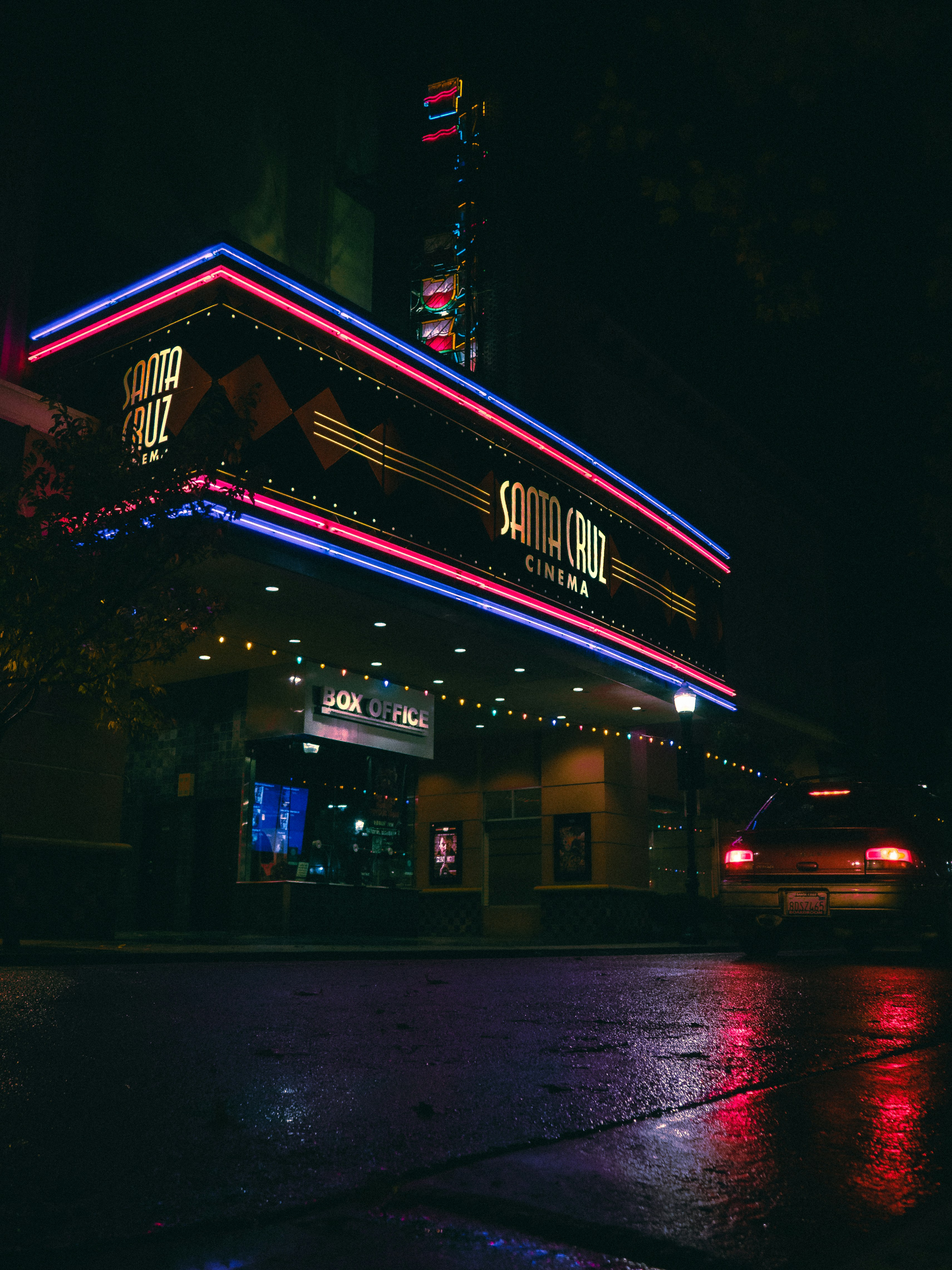 Neon Ribbons Over Santa Cruz Cinema on a Rain-Slick Night