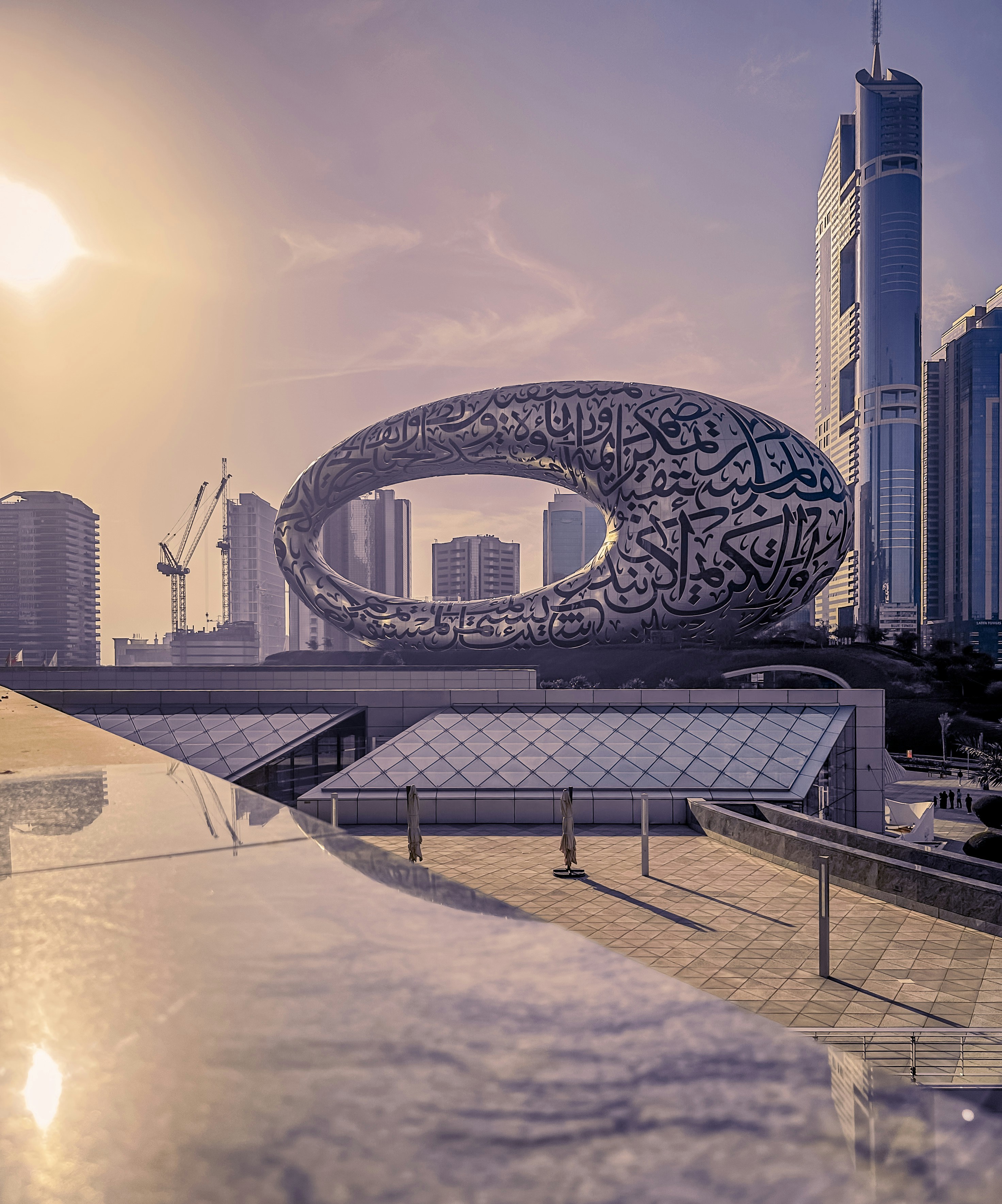 Calligraphic Ring at Sunset: A Loop of Text Framing the Modern Skyline