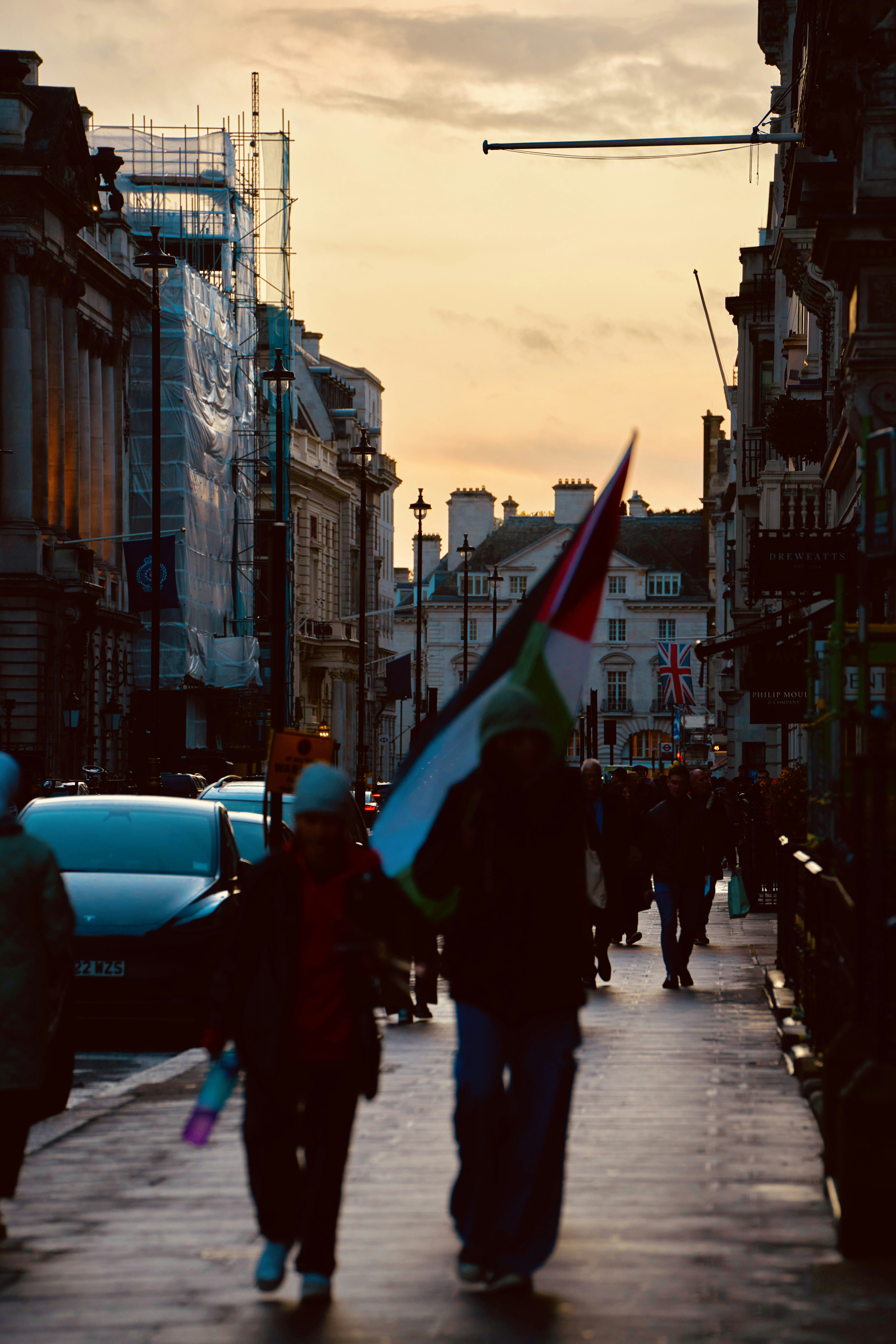 Flag Bearer at Sundown: A City Street in Silhouette
