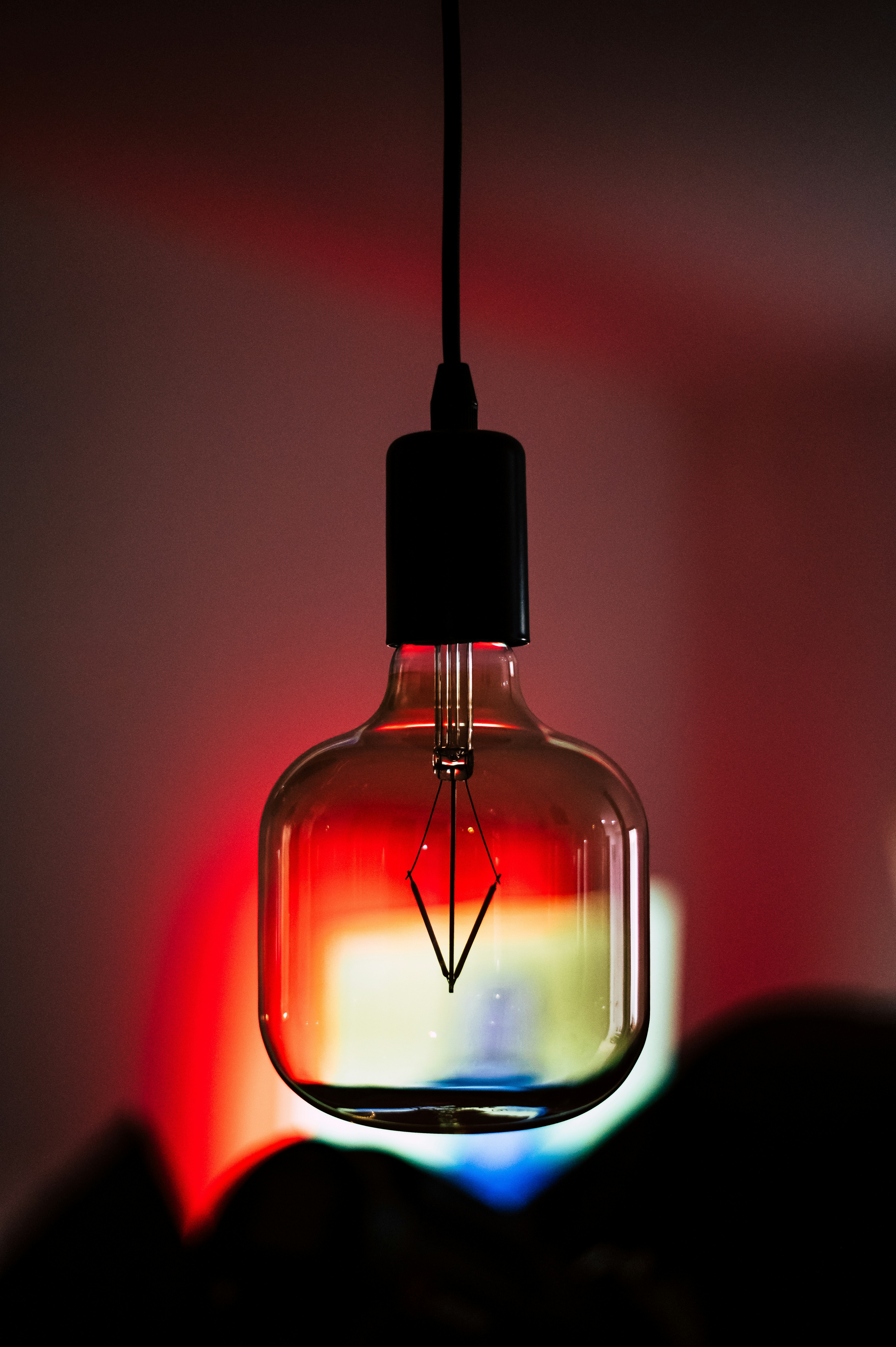 A light bulb hanging from a ceiling in a dark room photo – Free Design ...