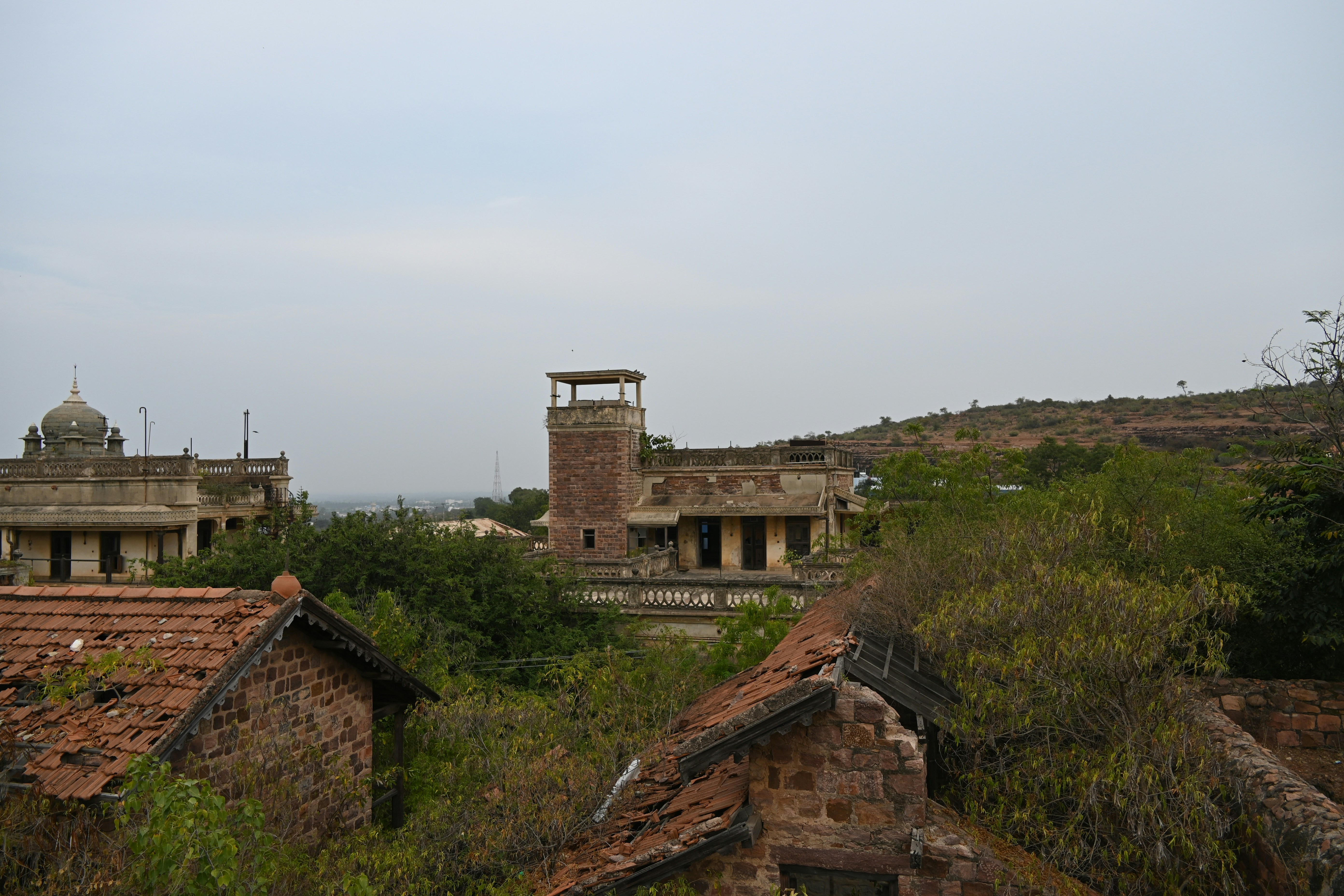 Hillside Sentinel: a weathered watchtower rising above terracotta roofs