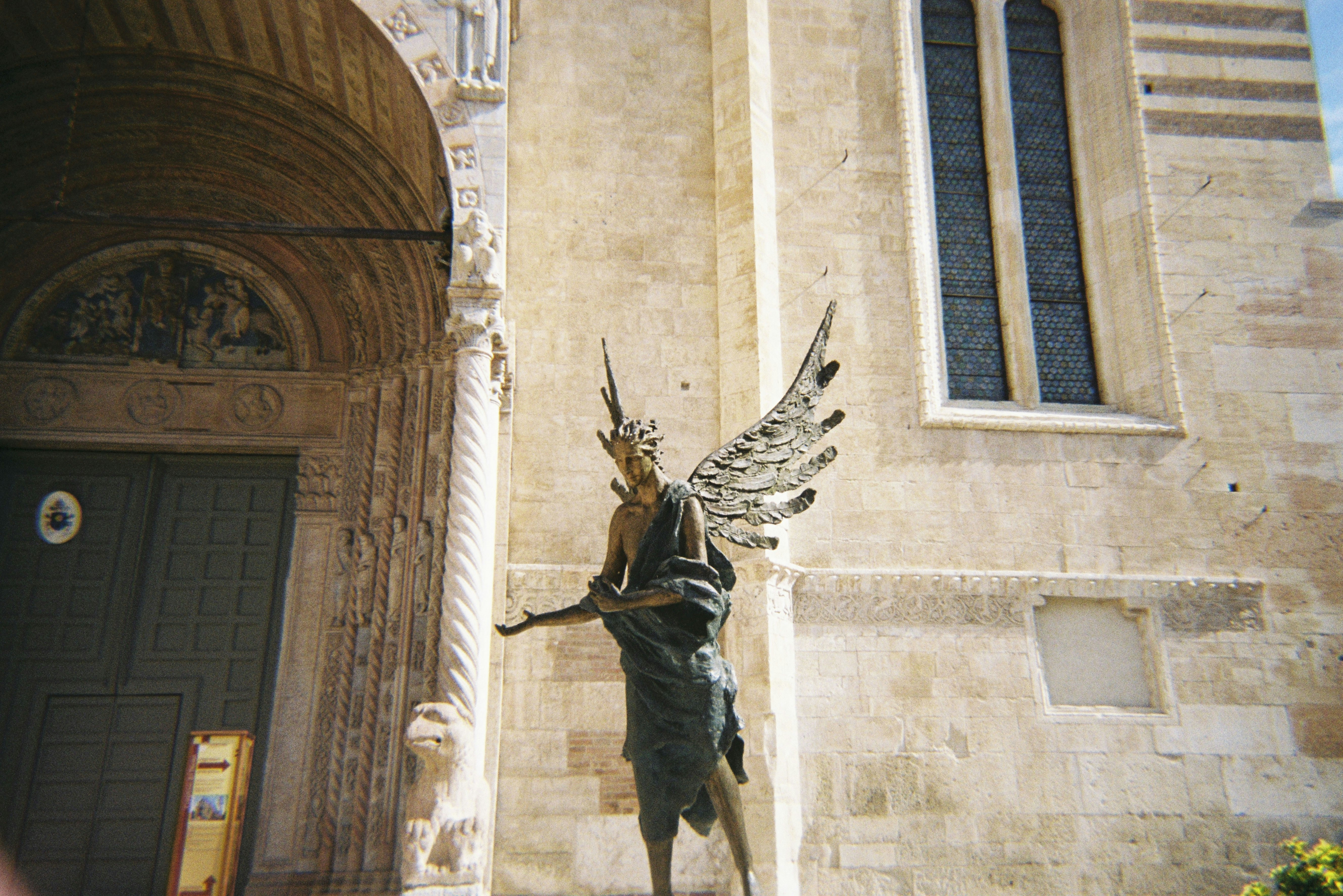 A statue of an angel is in front of a building photo – Free Summer ...