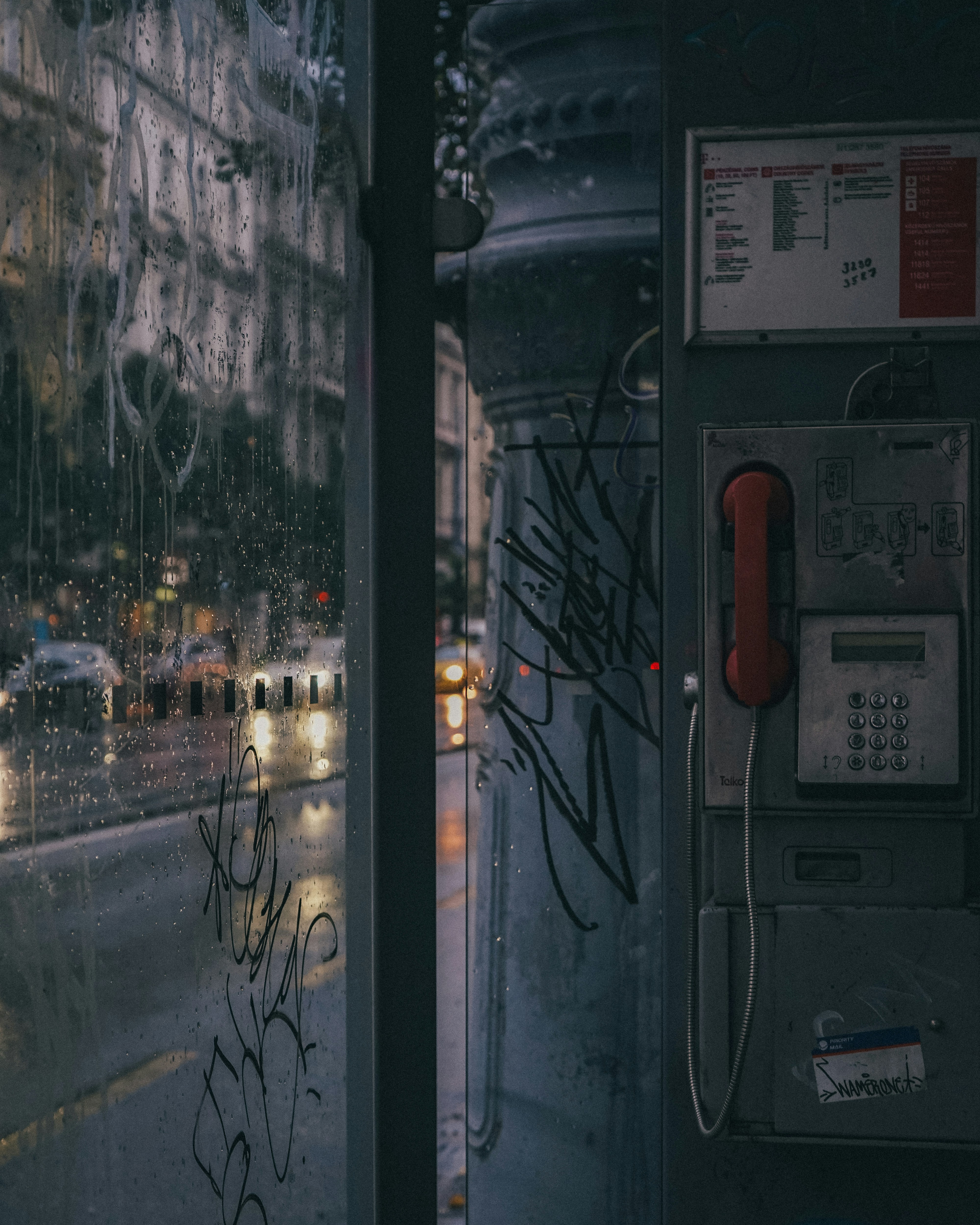 A phone booth with a lot of writing on it photo – Free Grey Image on ...