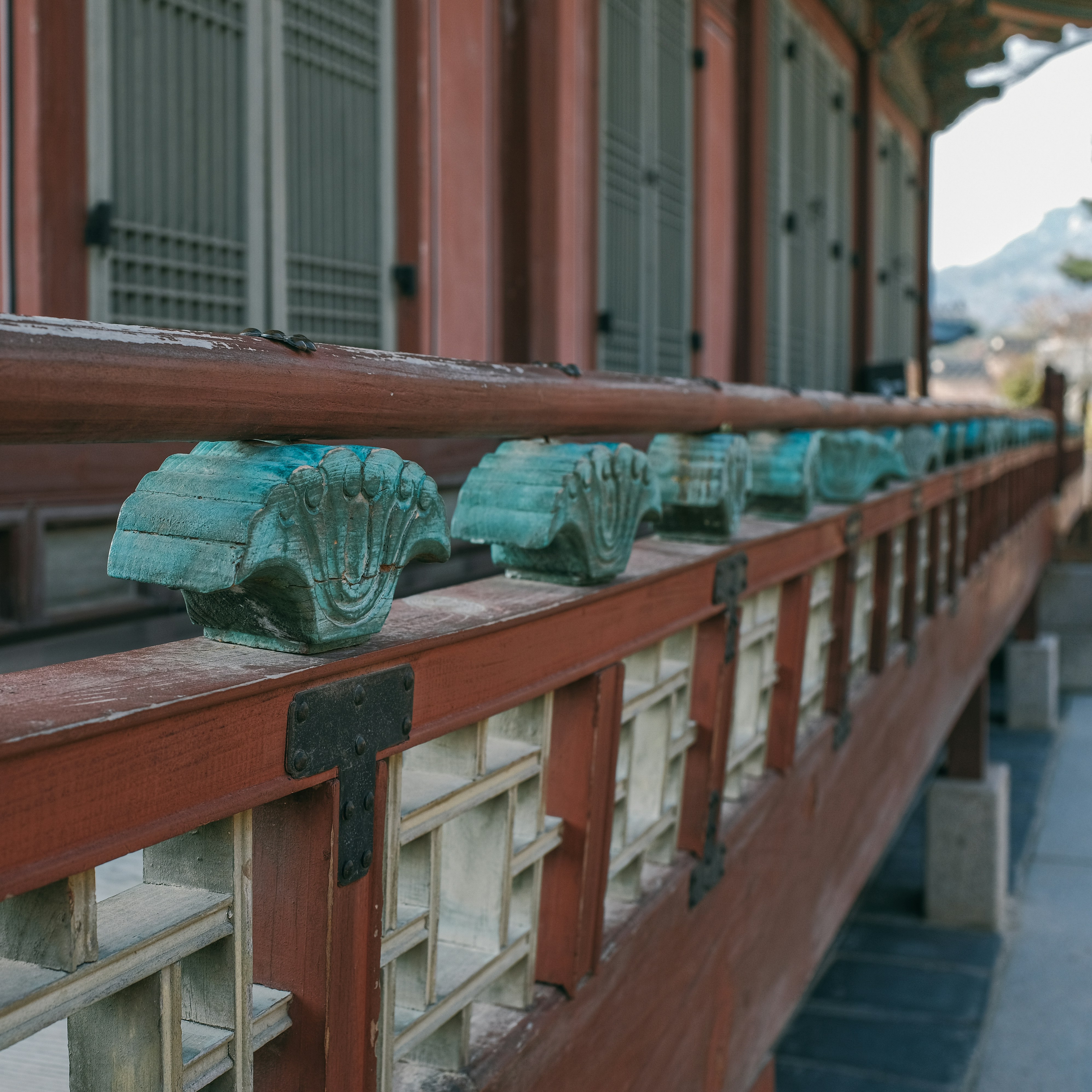 Teal Ridge Ornaments Trace a Crimson Temple Corridor