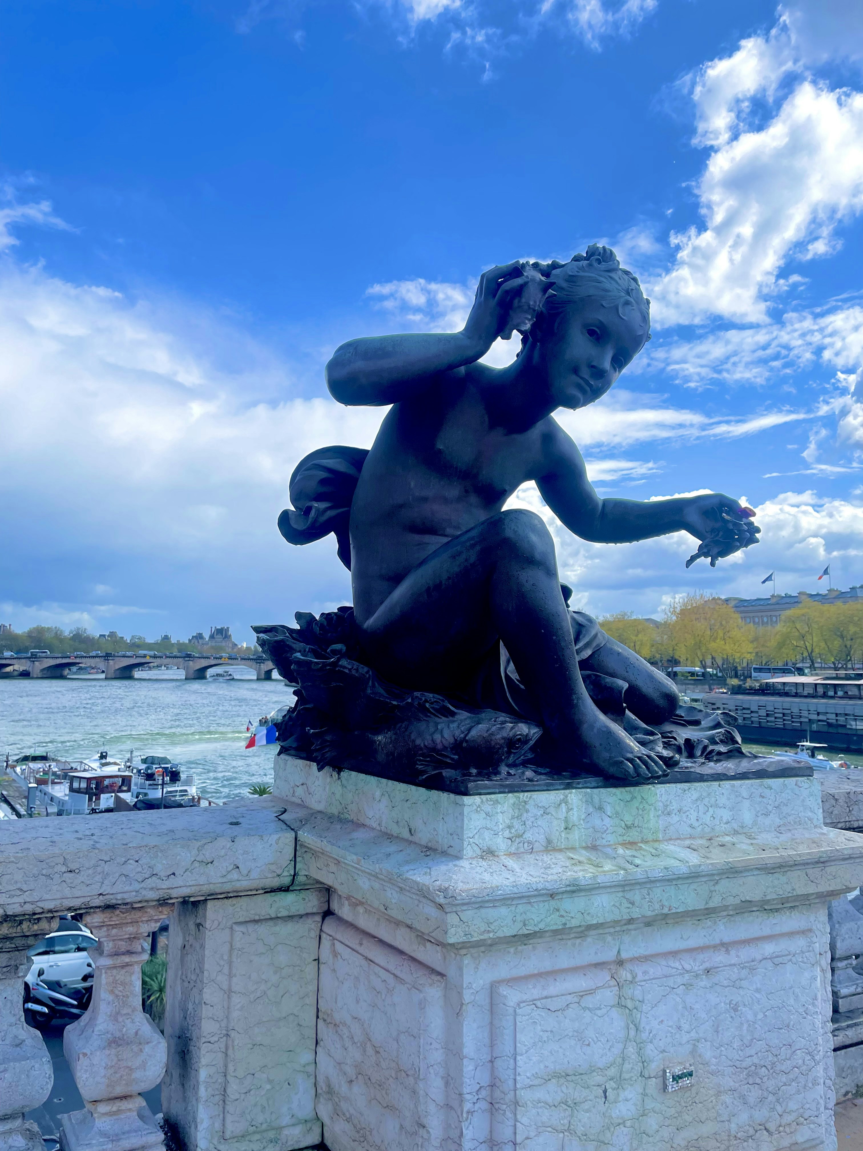 Bronze Cherub on a Stone Plinth Overlooking the River