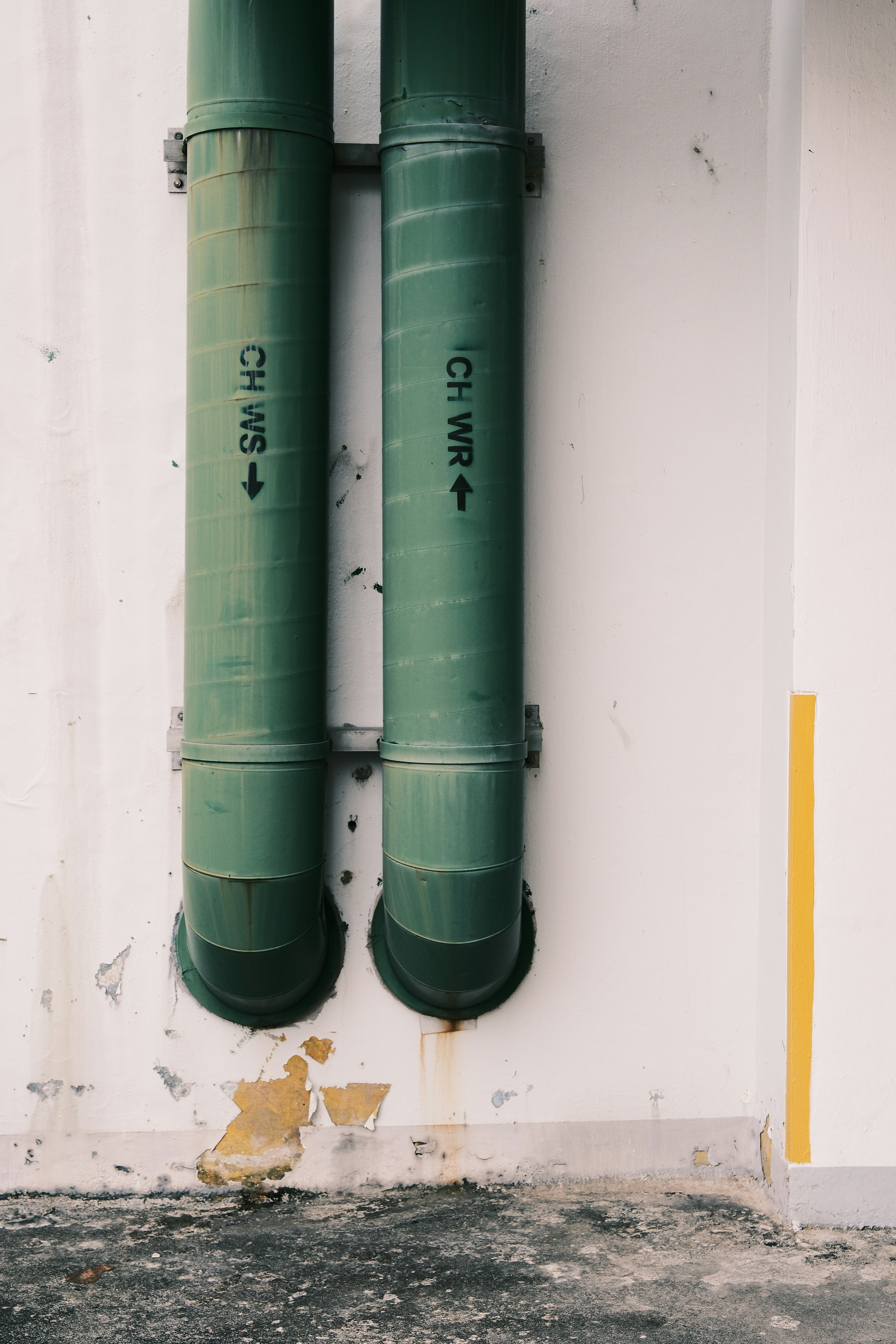 Two green pipes are attached to a white wall photo – Free Grey Image on ...