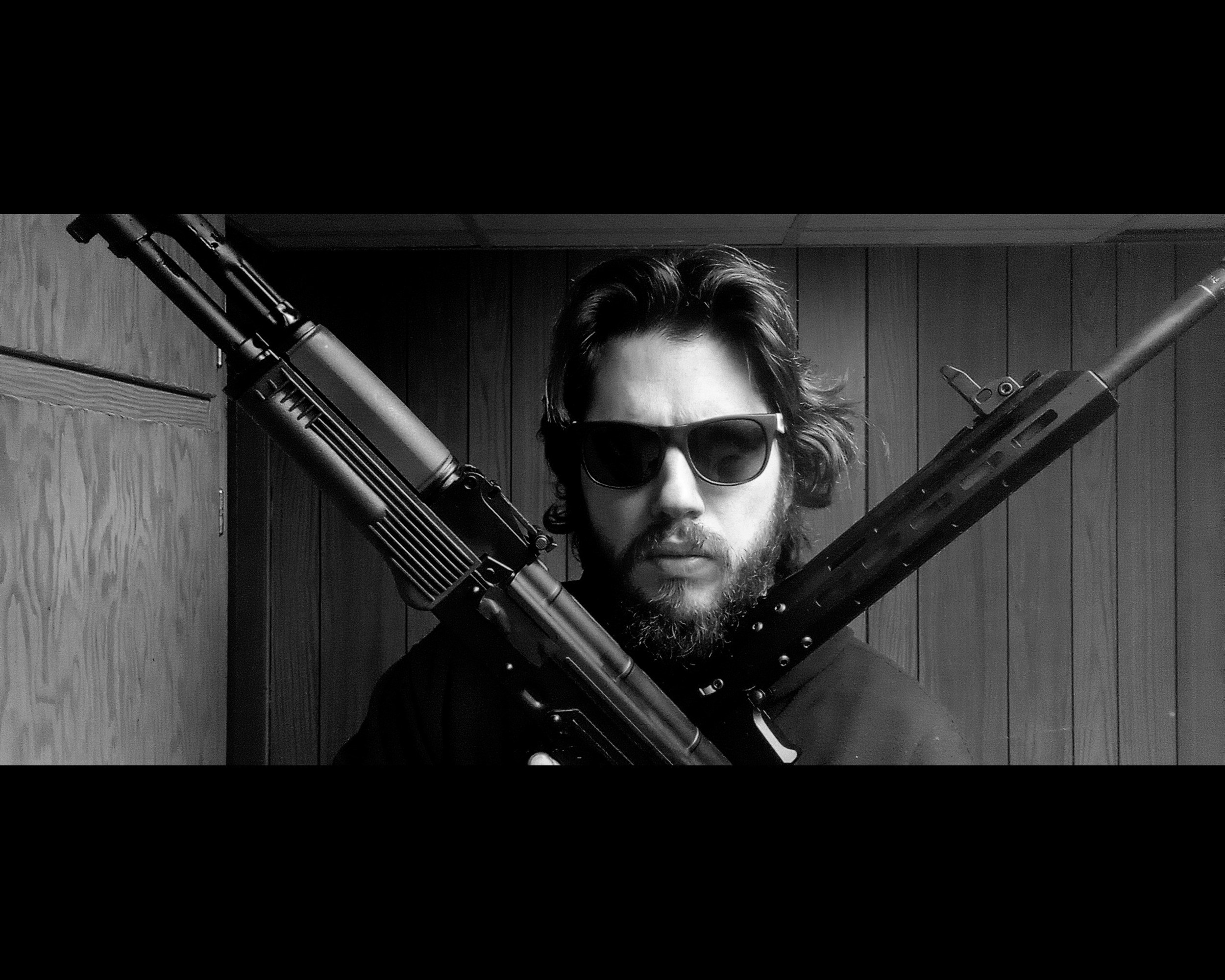 A man holding a bunch of guns in his hands photo – Free Rifle Image on ...