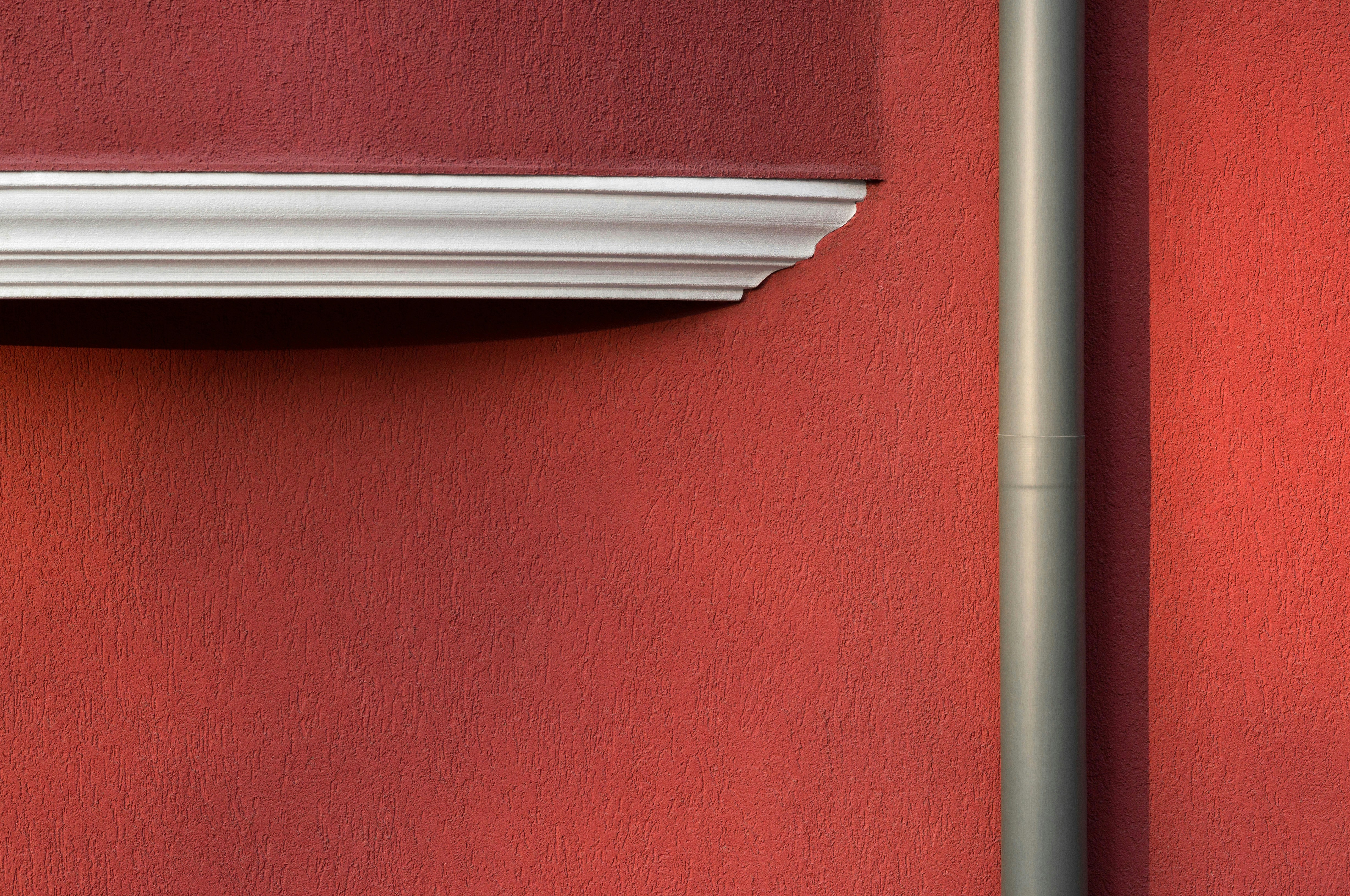 Scarlet Facade, White Trim, and a Steel Pipe: A Minimalist Architectural Moment