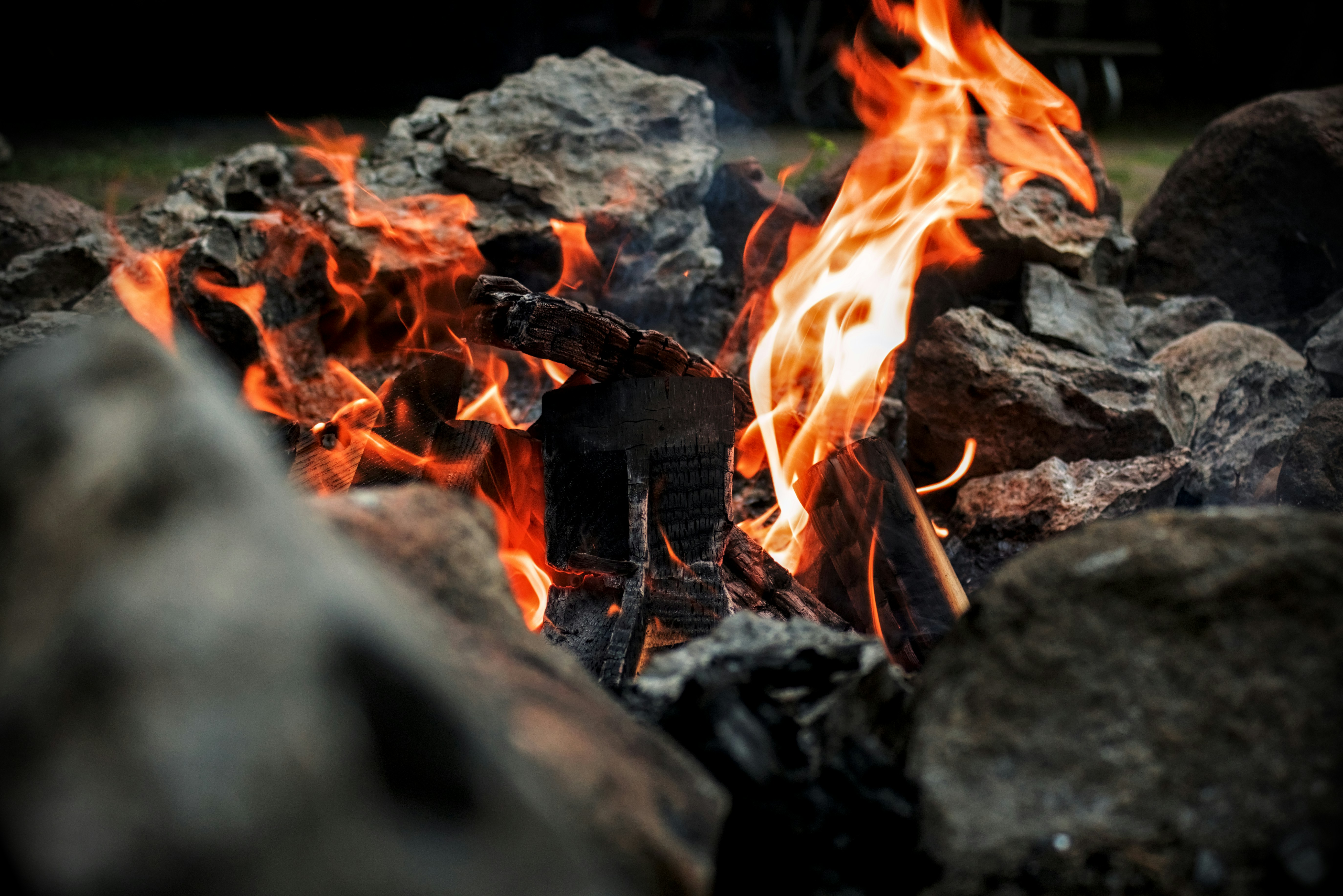 A close up of a fire with rocks in the background photo – Free Flame ...