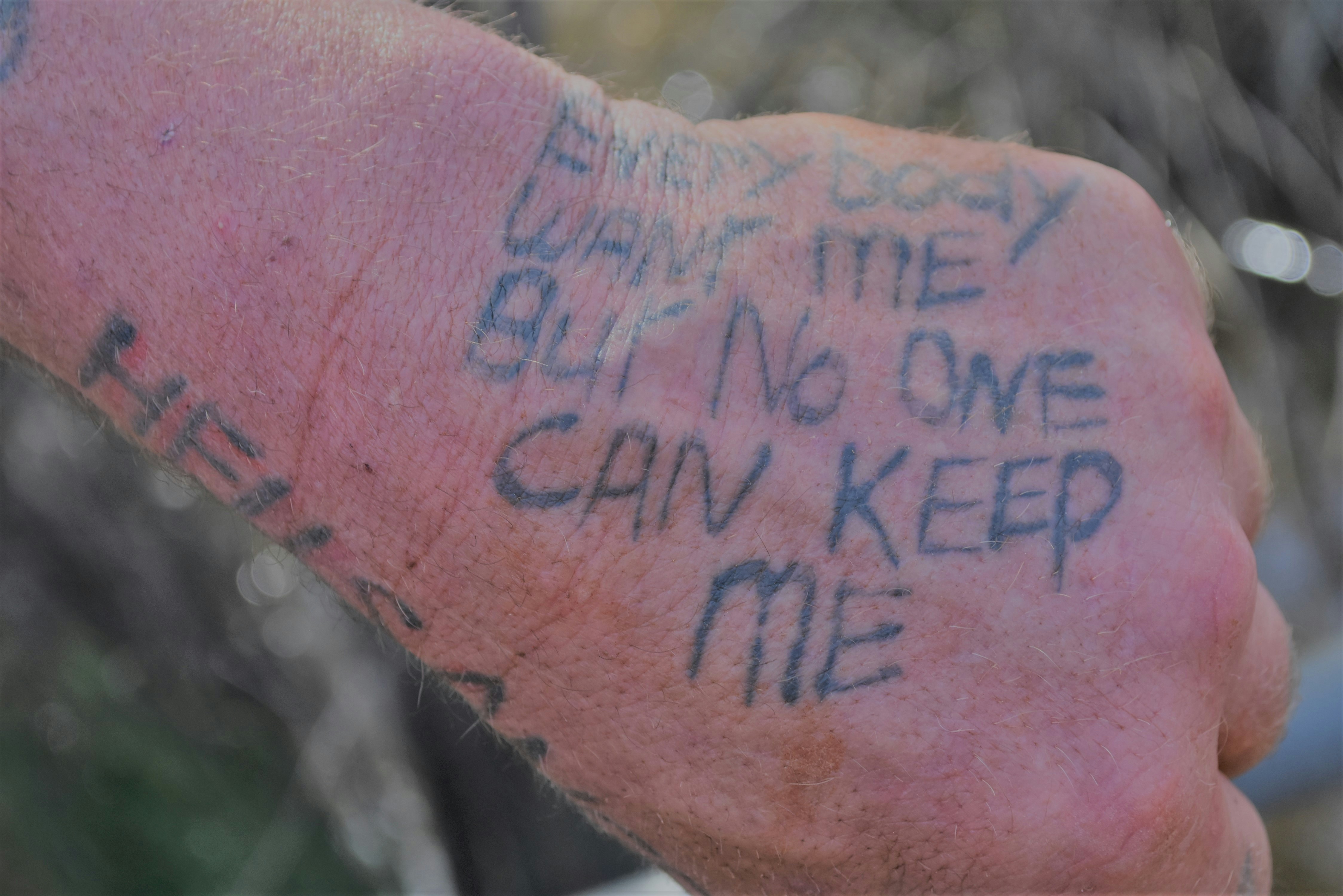 Ink on Skin: A Worn Message etched in Sunlit Texture