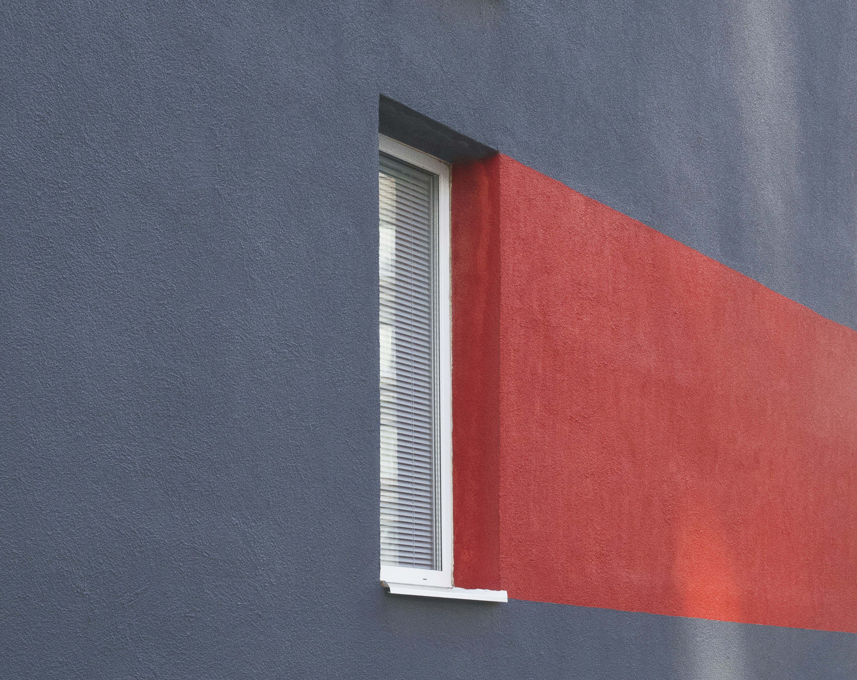 A red and blue building with a white window photo – Free Wall Image on ...