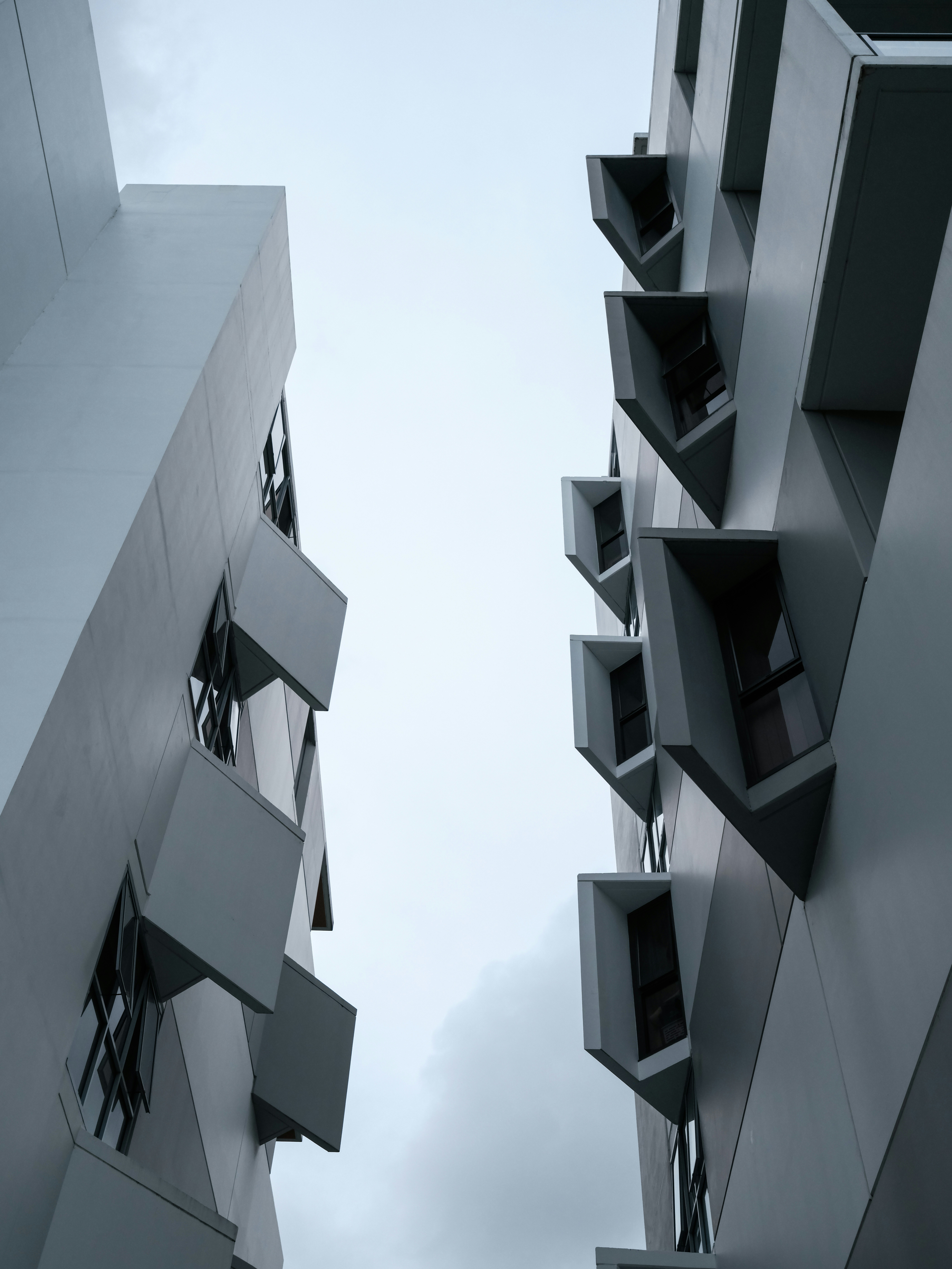 A couple of tall buildings next to each other photo – Free Blue Image ...