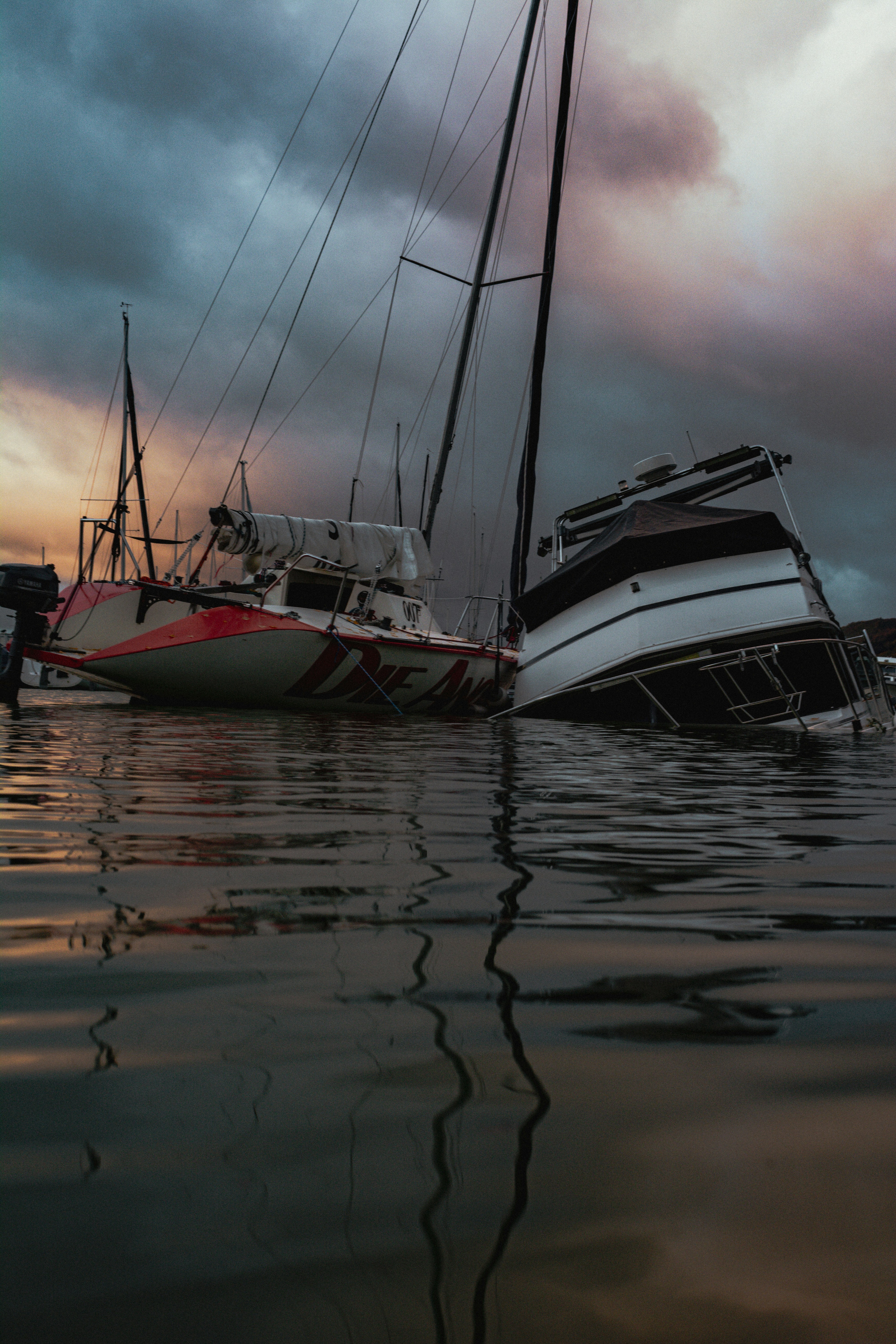 Twilight Tilt: Leaning Sails and Reflections in a Quiet Harbor
