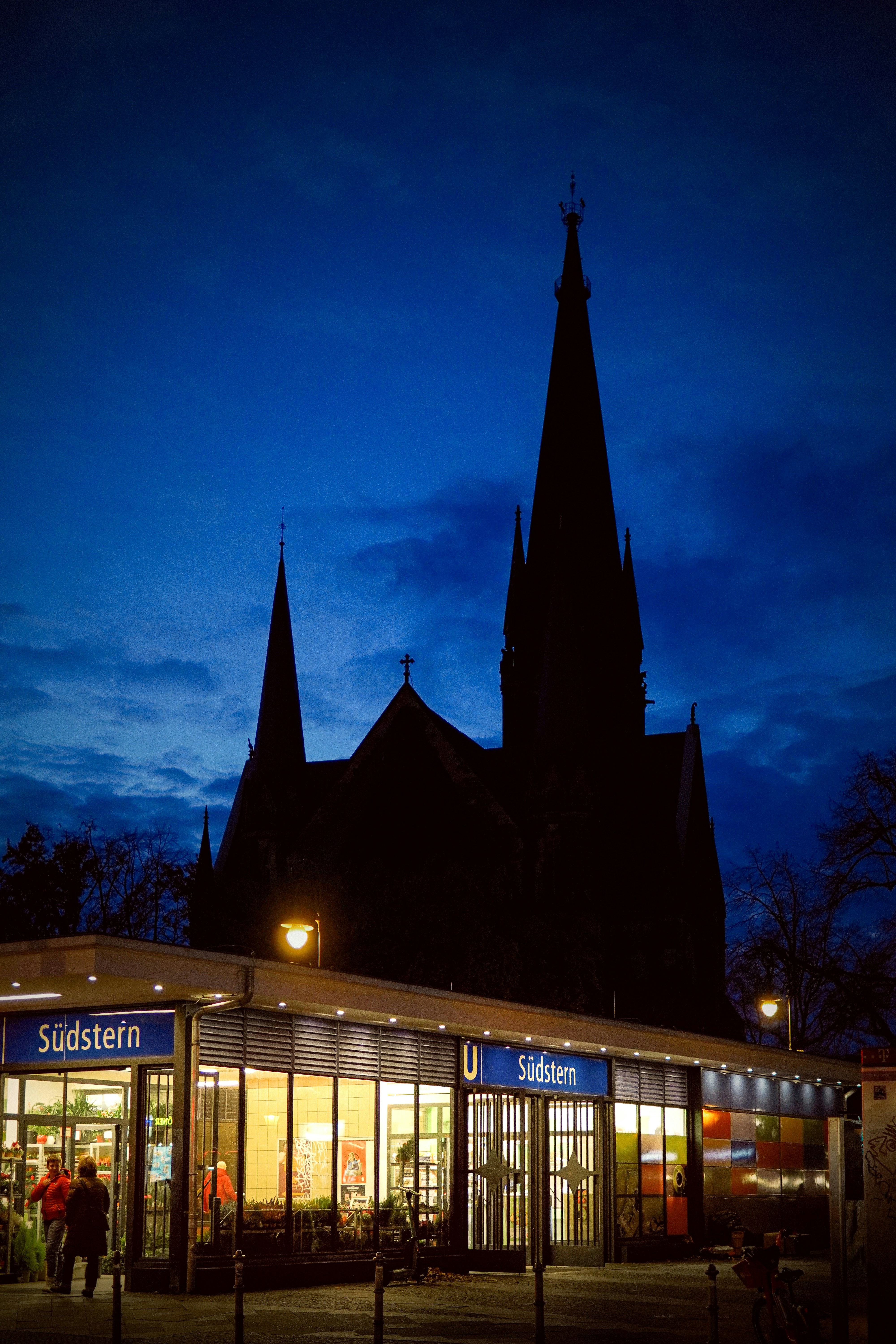 Nocturnal Gothic: Spire Silhouette Over a Neon-Glow Street