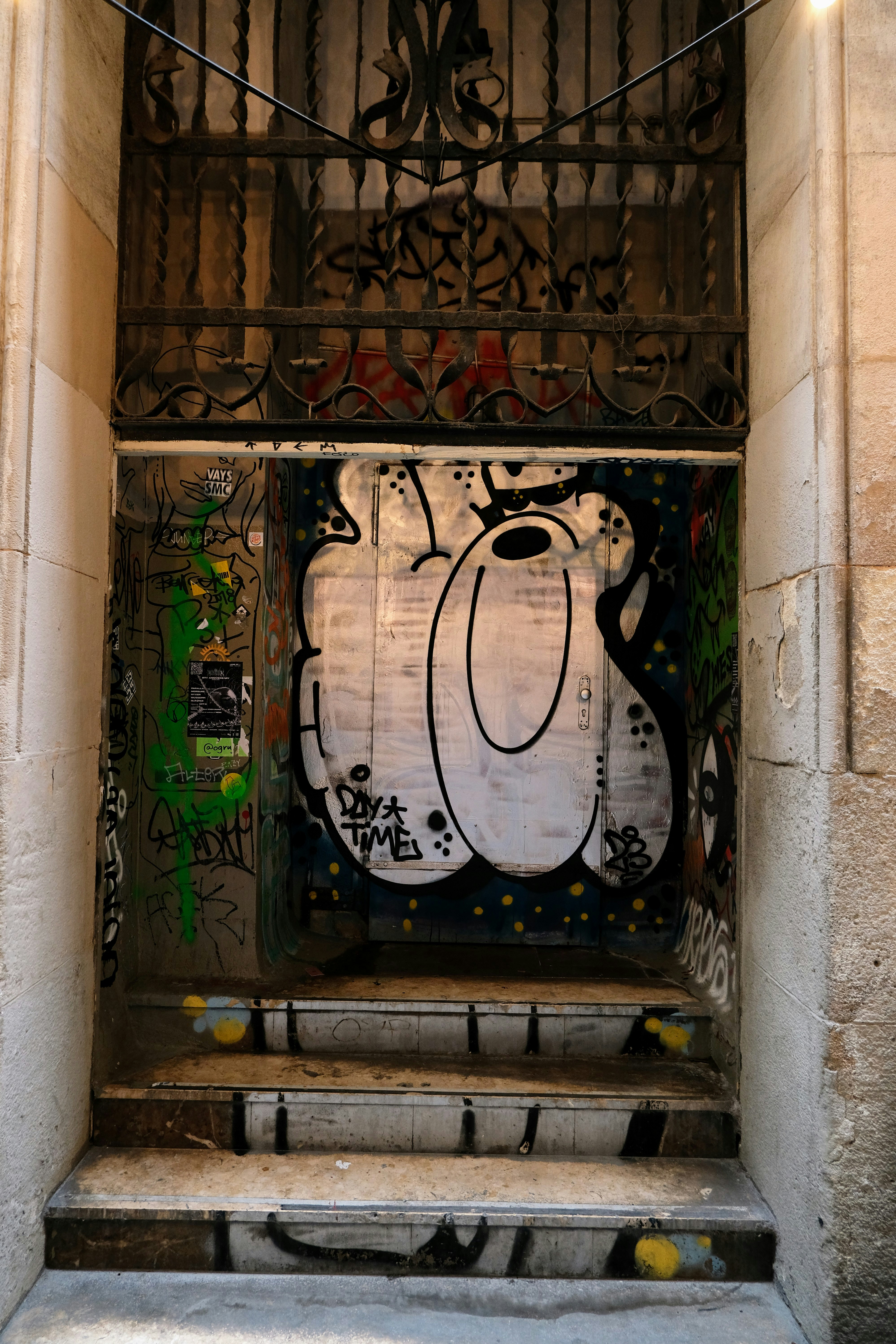 A doorway with a bunch of graffiti on it photo – Free Barcelona Image ...