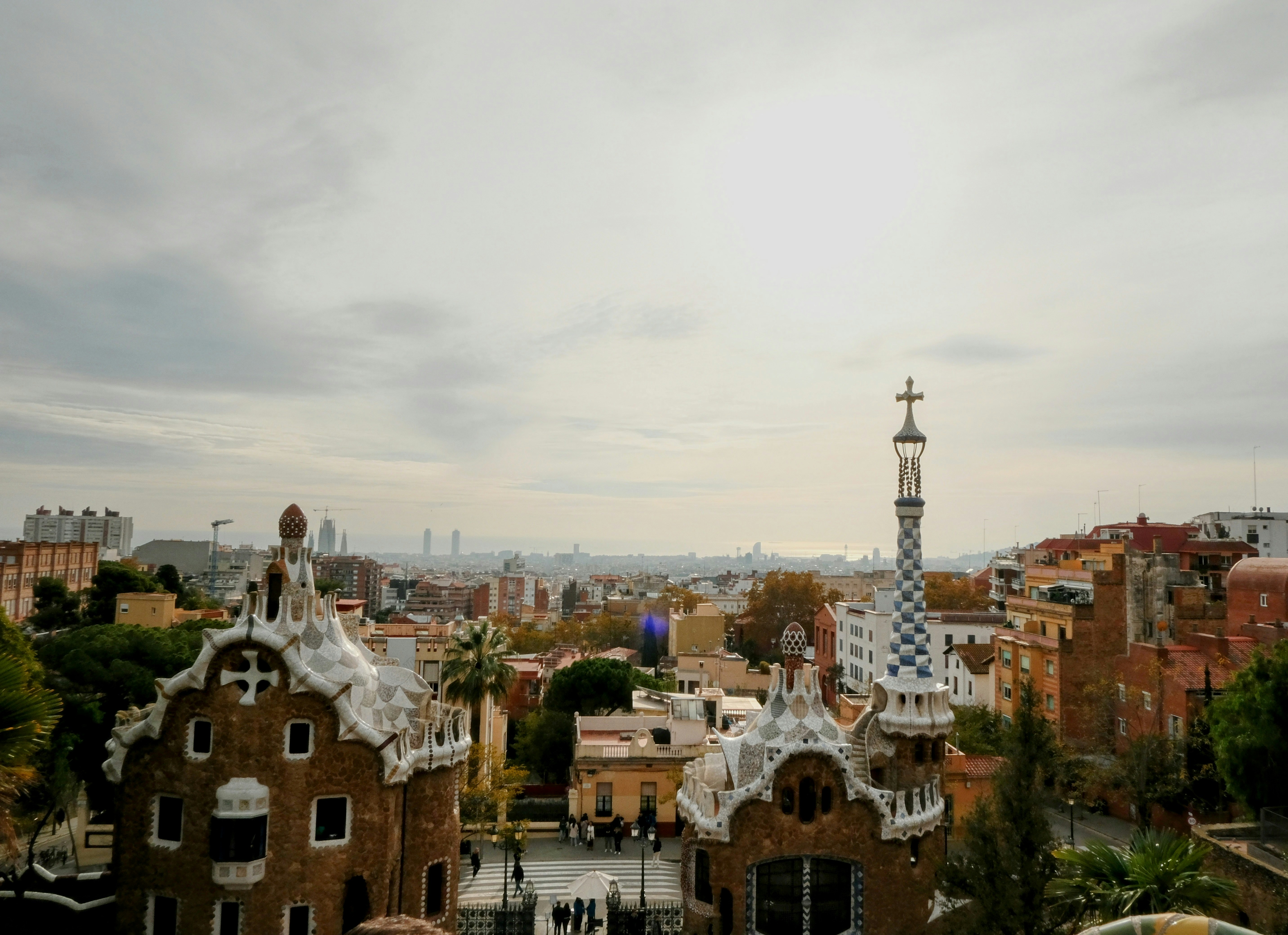 Park Güell Mosaic Towers Framing a Sunlit Barcelona Horizon