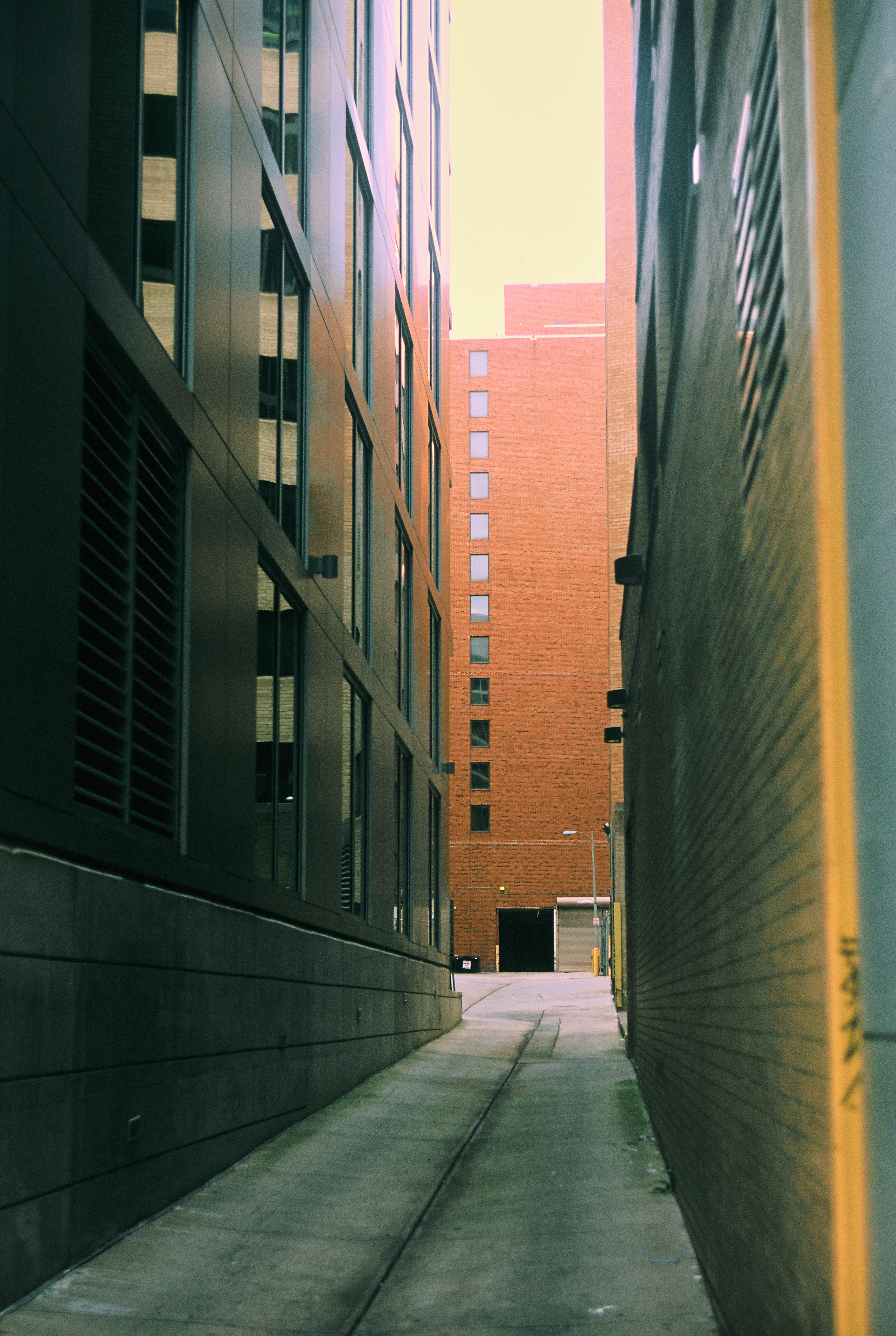 A narrow city street with tall buildings in the background photo – Free ...