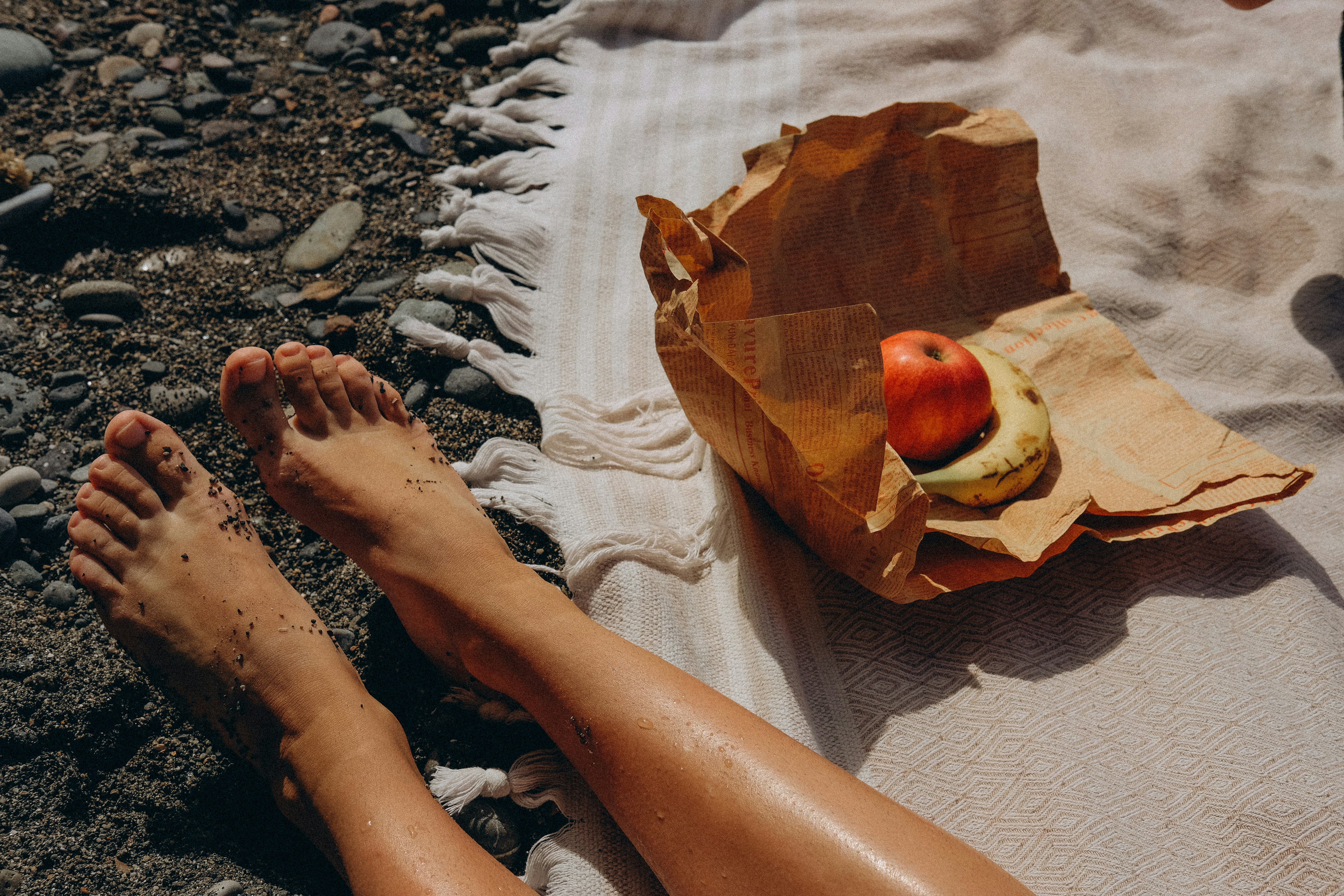 Sun‑Kissed Feet and Picnic Essentials on a Pebble Beach