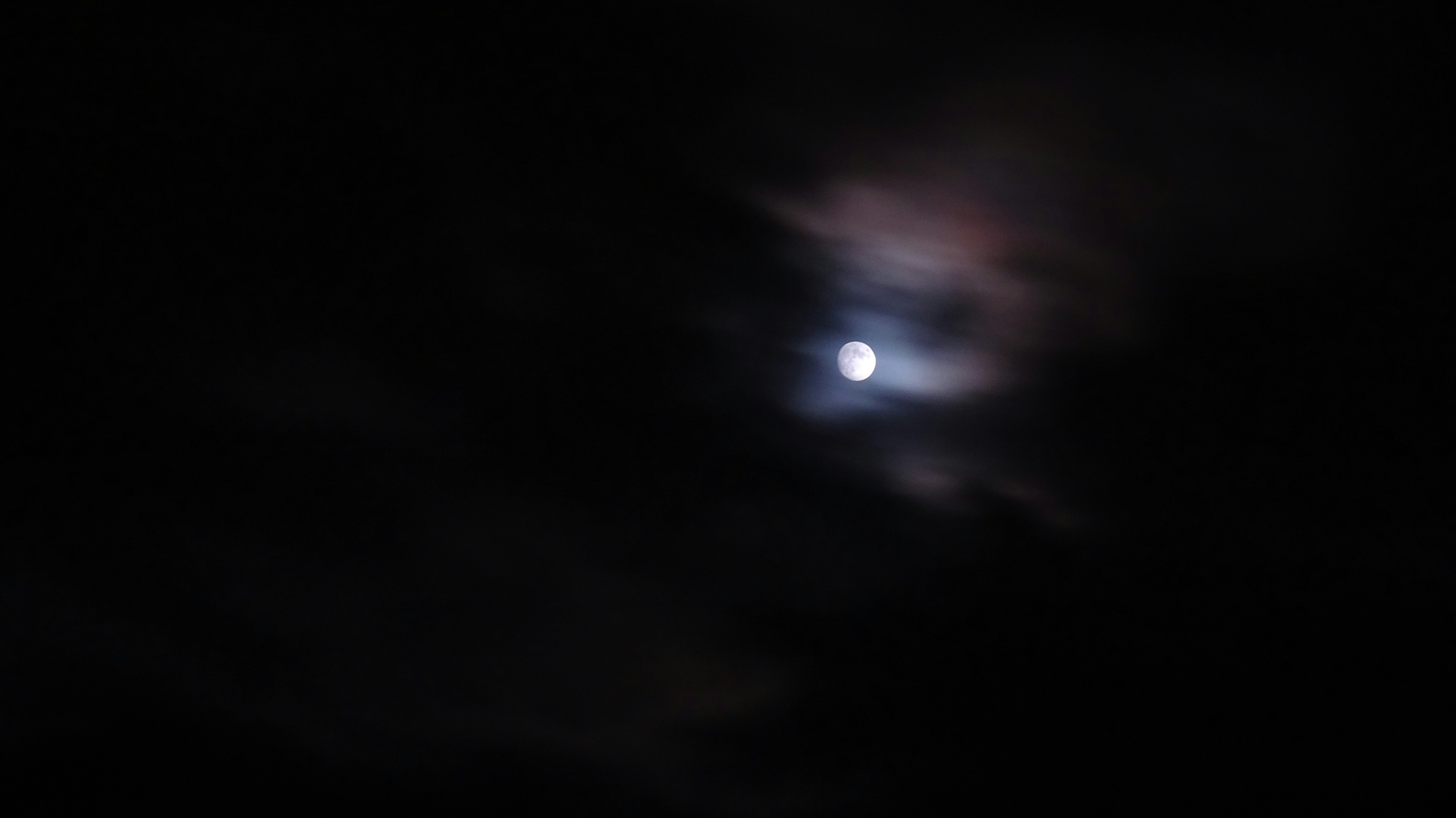 Moon Through a Veil: Lunar Glow in Quiet Clouds