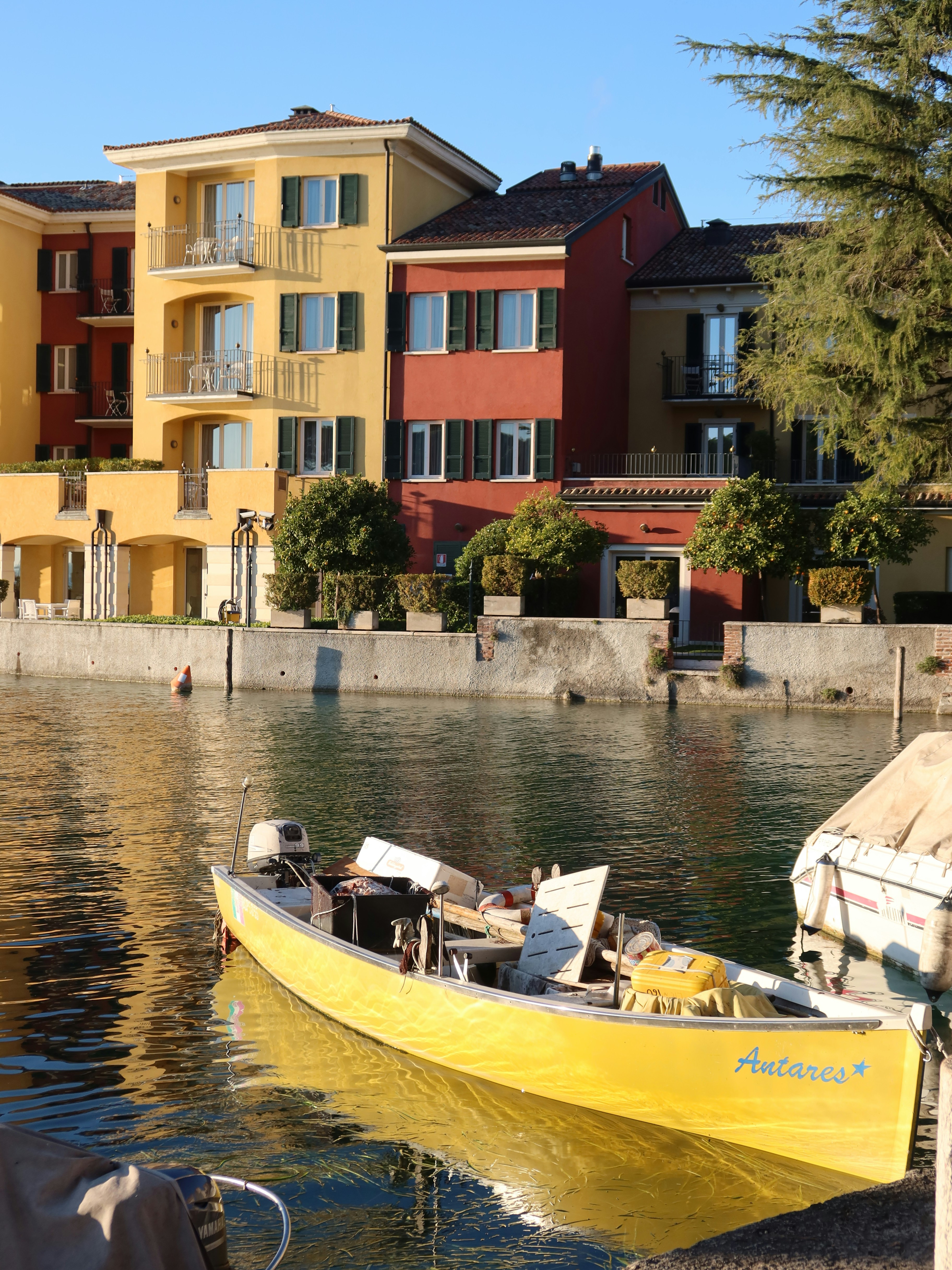 Yellow Boat by a Colorful Canalfront Building
