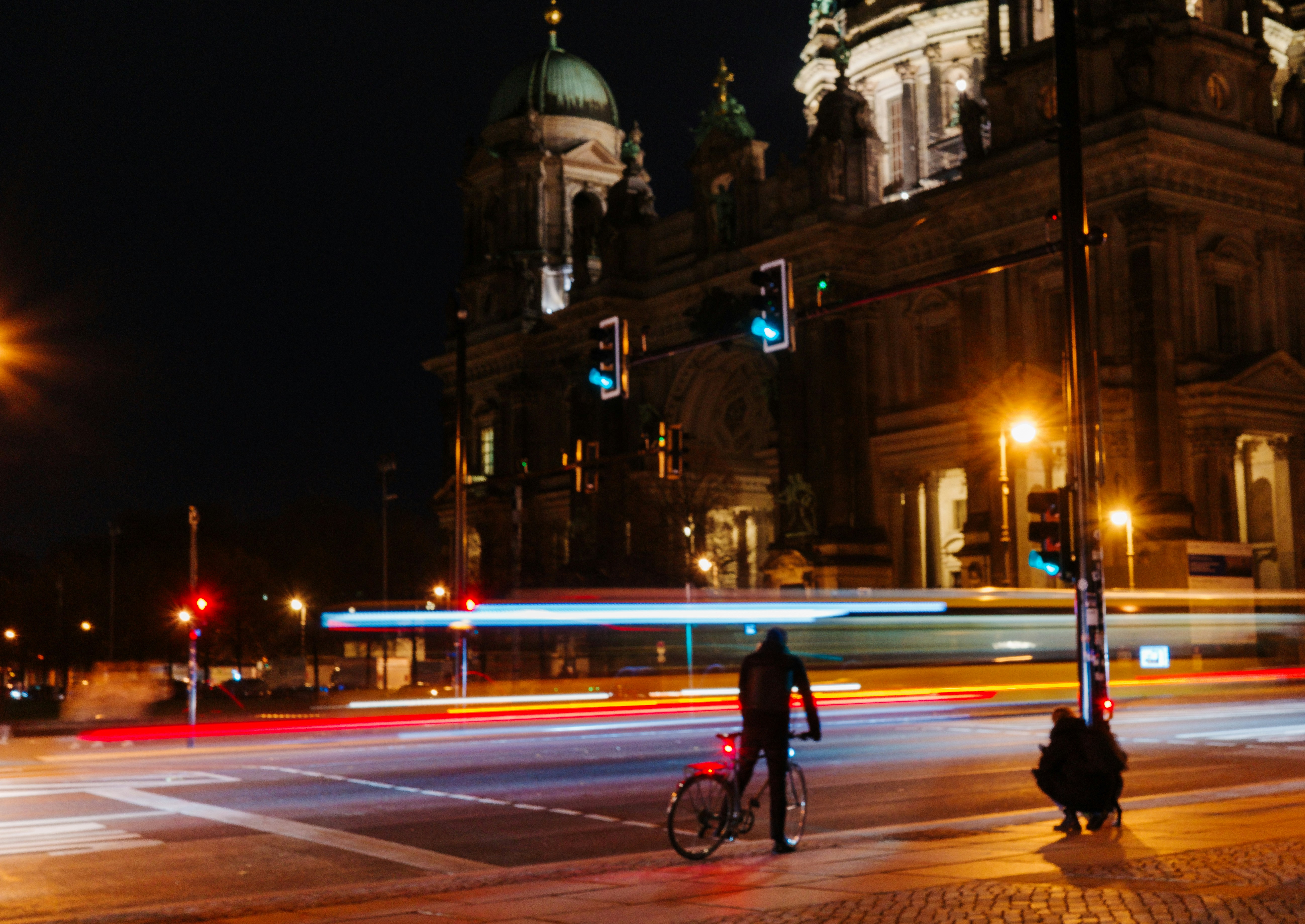 Velocities in Velvet Night: A Biker's Pause by a Baroque Facade