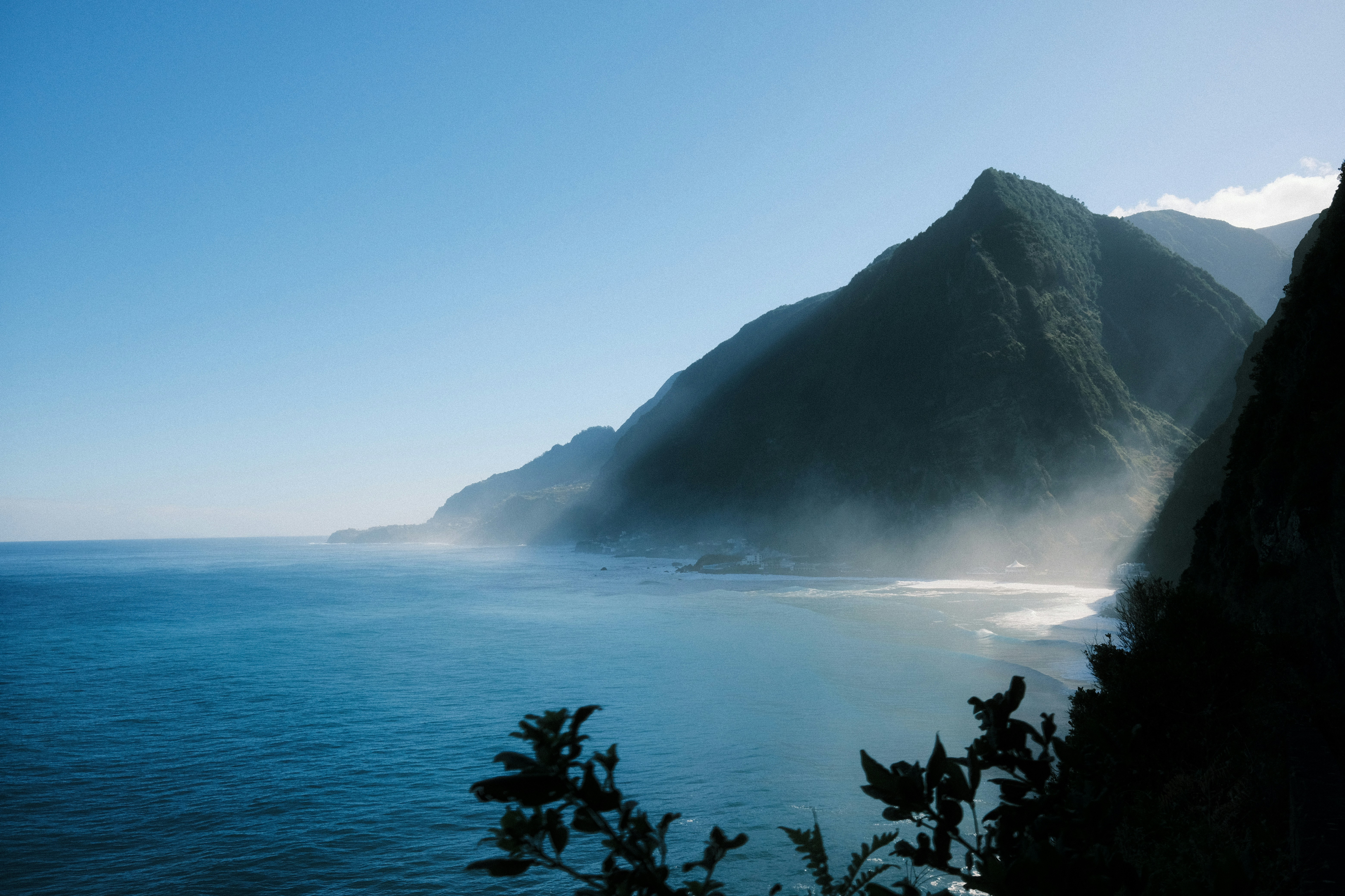 Beauty of the Madeira island | a large body of water with a mountain in the background