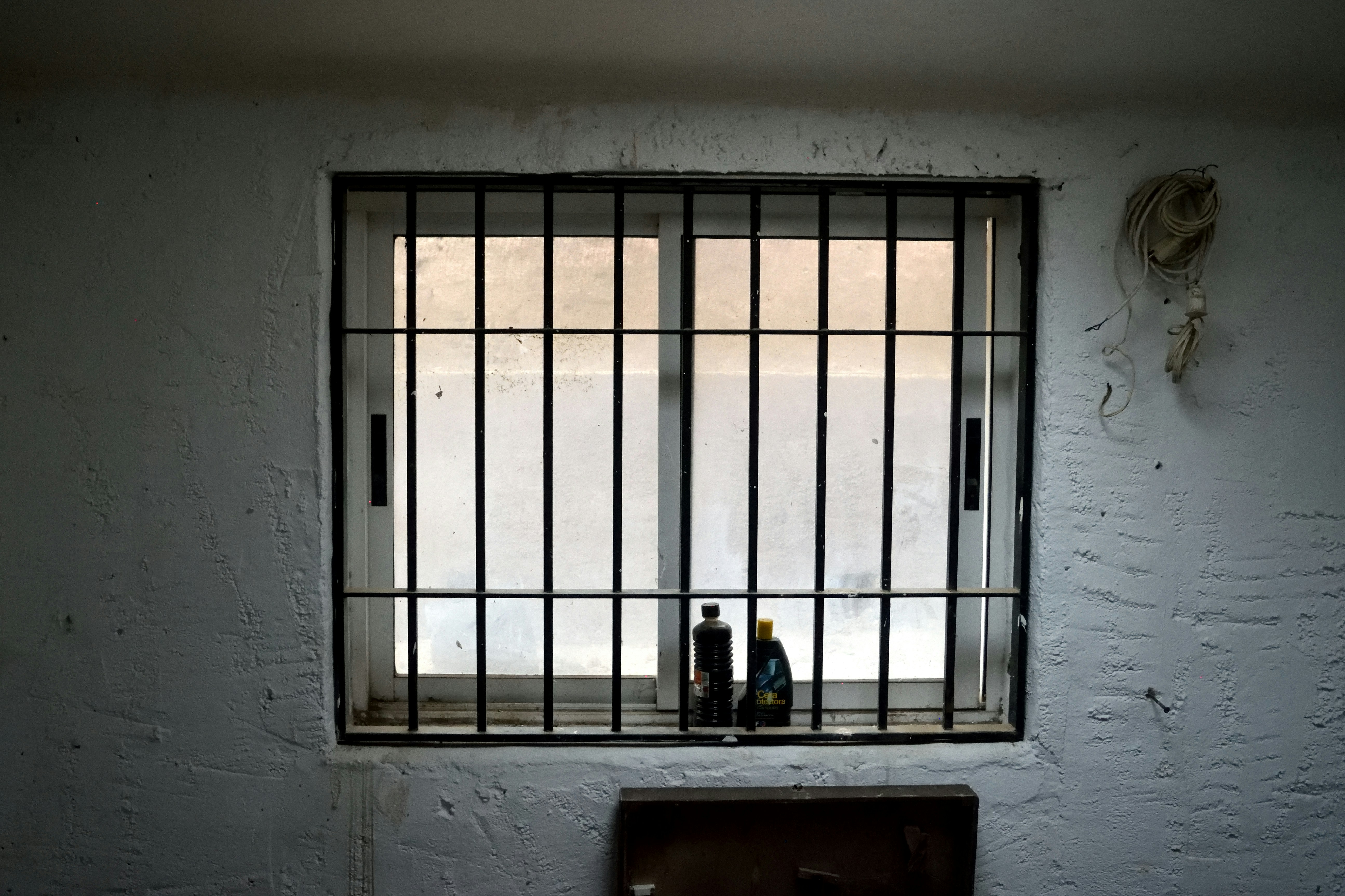 A jail cell with two bottles of alcohol behind bars photo – Free ...